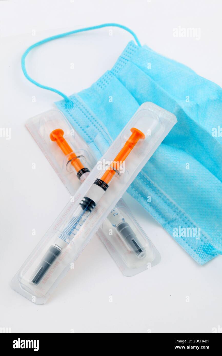 A vertical shot of syringe and mask isolated on white background Stock ...