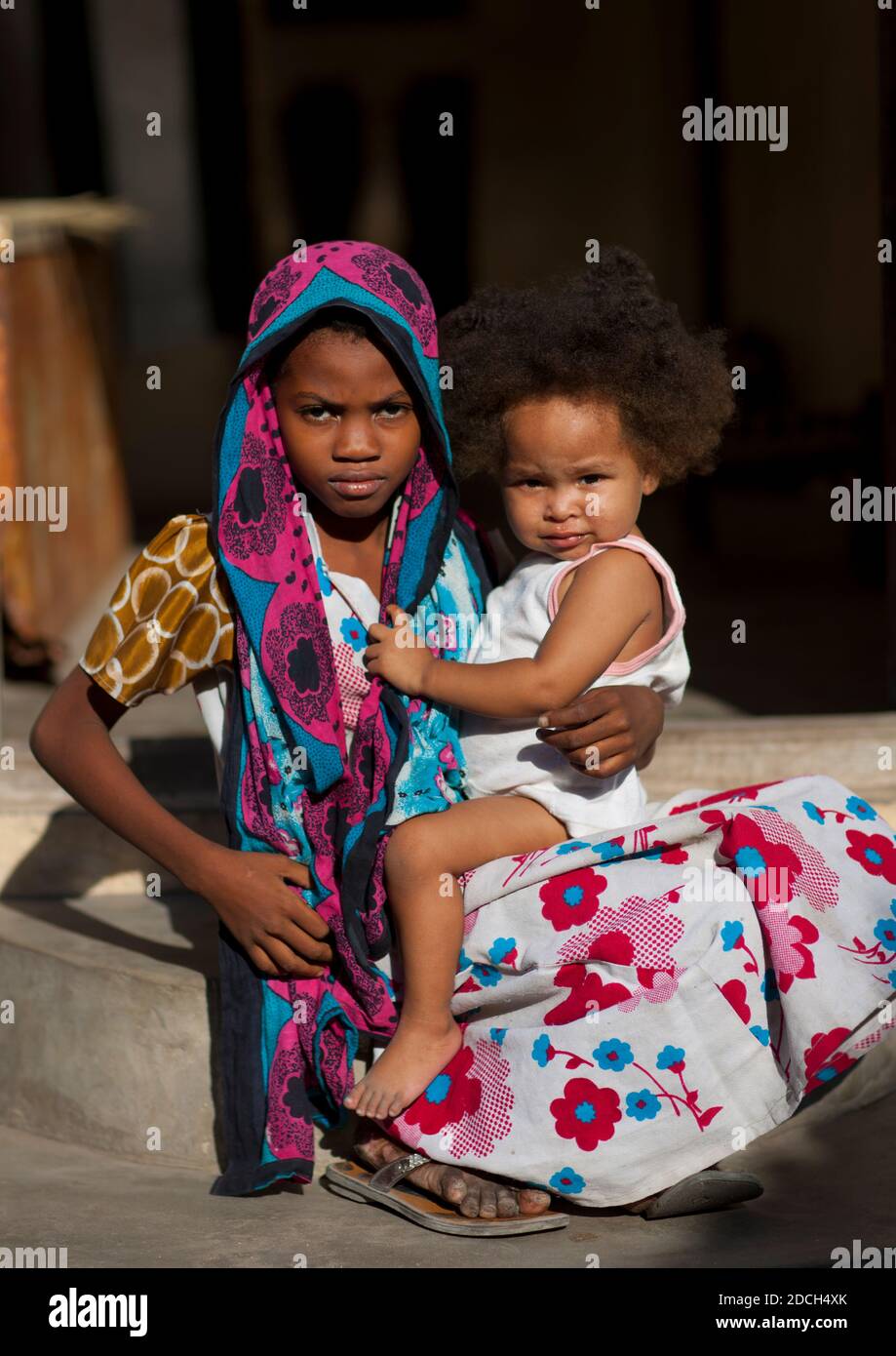 Muslim teenage girl holding a little girl, Lamu County, Matondoni ...