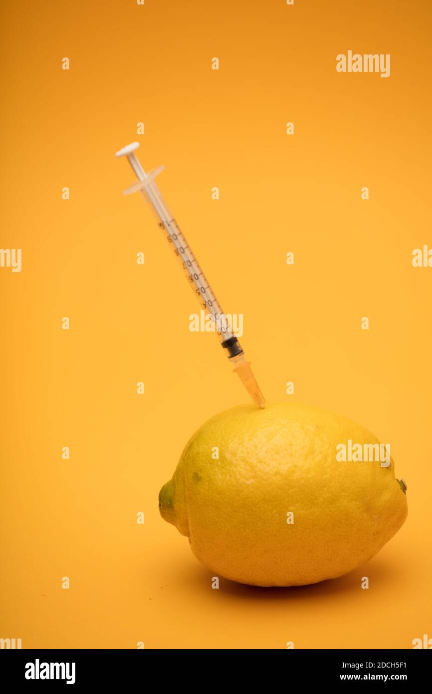 lemon with stuck syringe, genetic modification experiment, orange ...