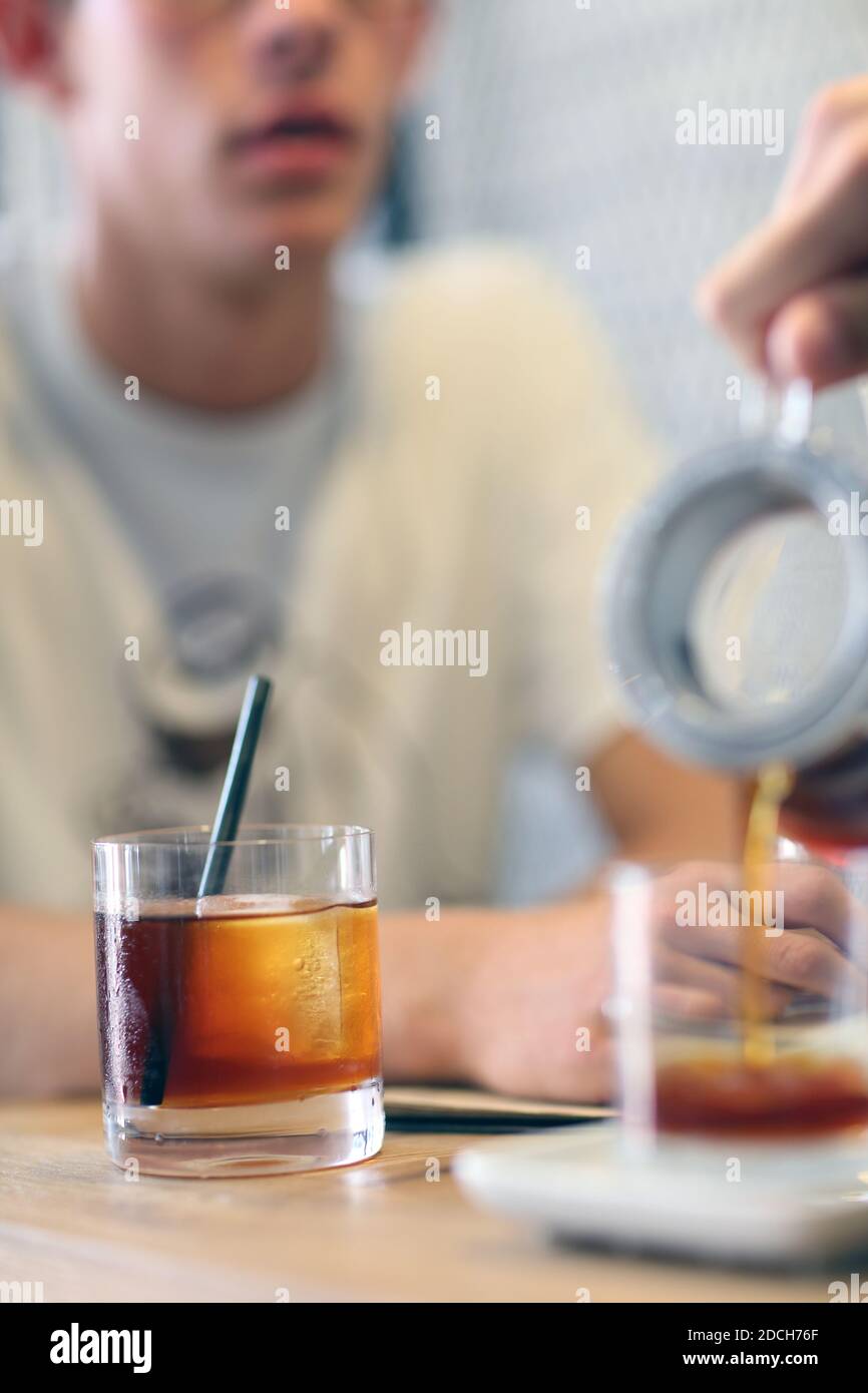 pouring cold brew coffee into glass Stock Photo - Alamy