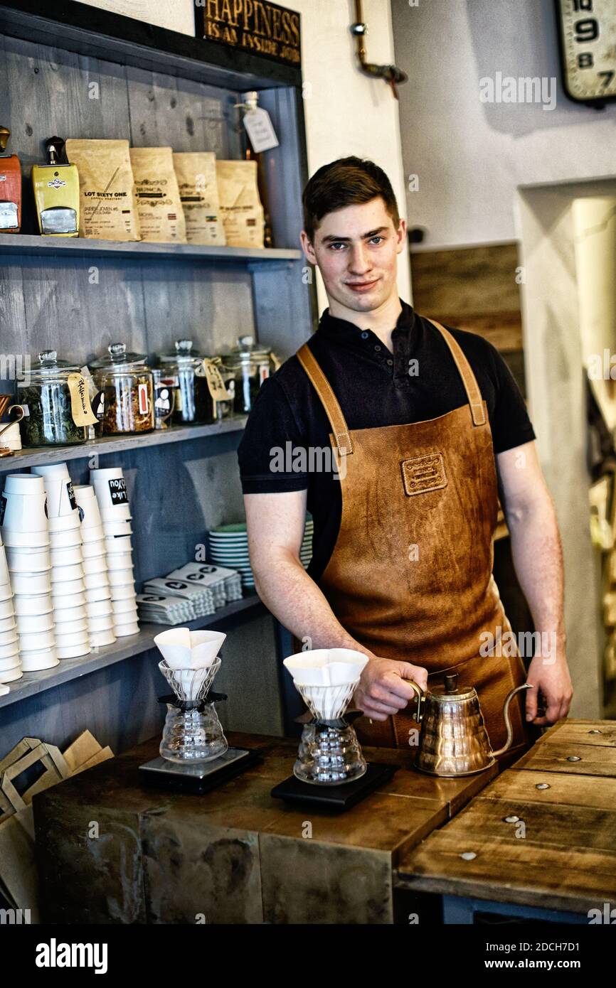 Young male barista using V60 to make filter coffee Stock Photo - Alamy