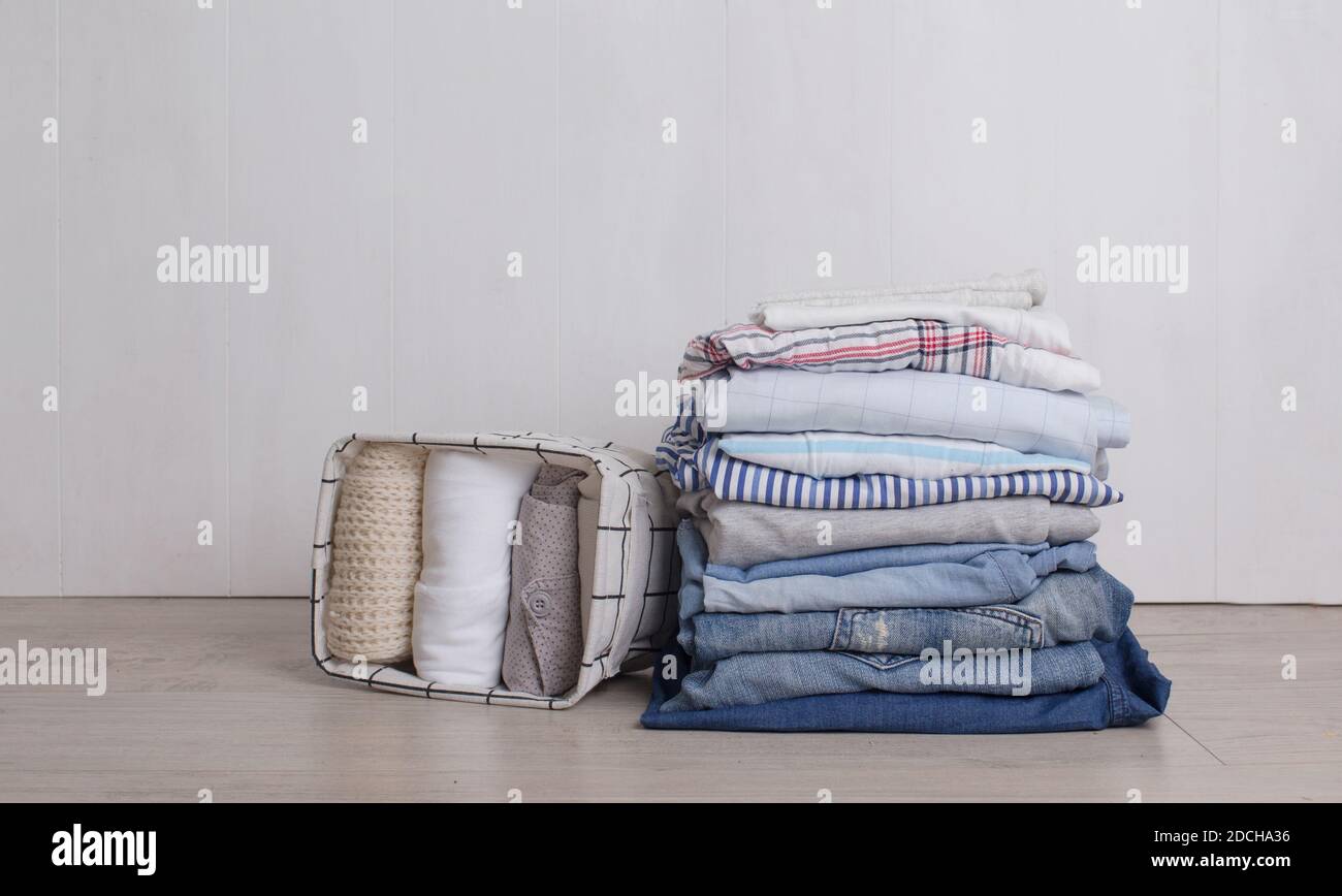 A stack of colorful, perfectly folded items of clothing. A bunch of ...