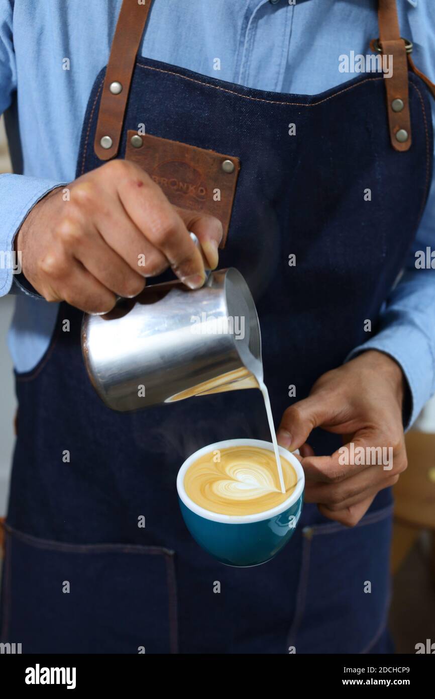 Coffee shop barista making flat white Stock Photo - Alamy