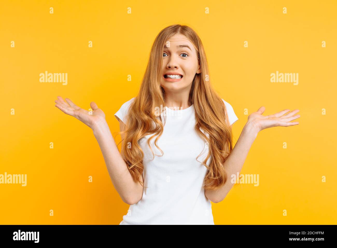 Angered woman shrugs, with indecisive expression on her face, in a ...