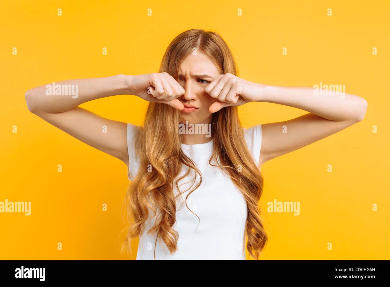 beautiful girl upset, woman crying on yellow background, bad mood Stock ...