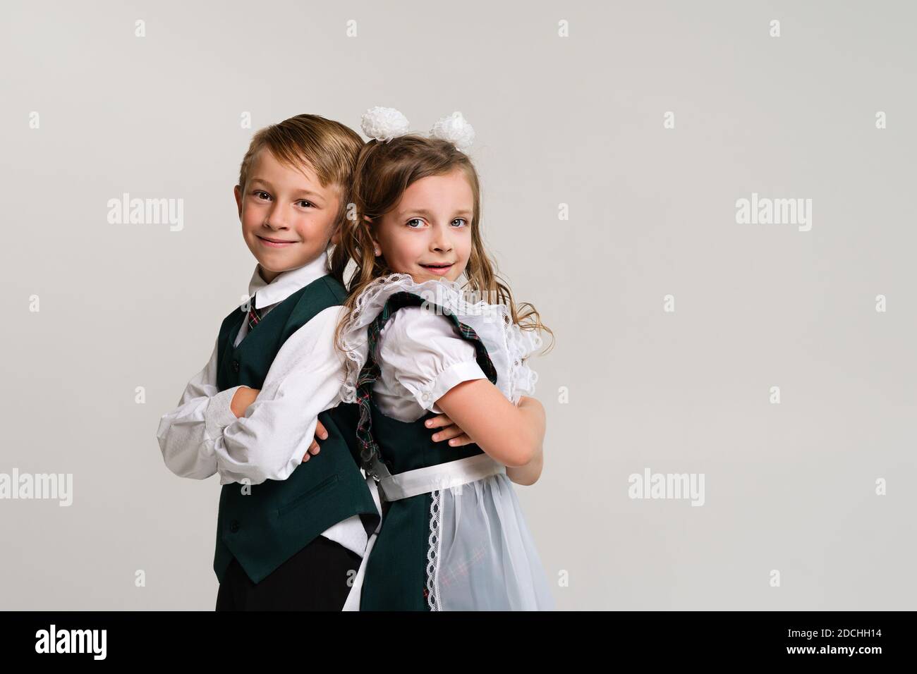 Portrait two of happy and smiling elementary school students in uniform ...