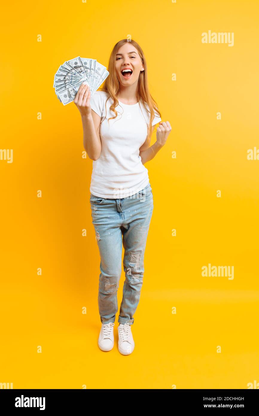 Portrait of happy contented girl in white t-shirt with a bunch of ...