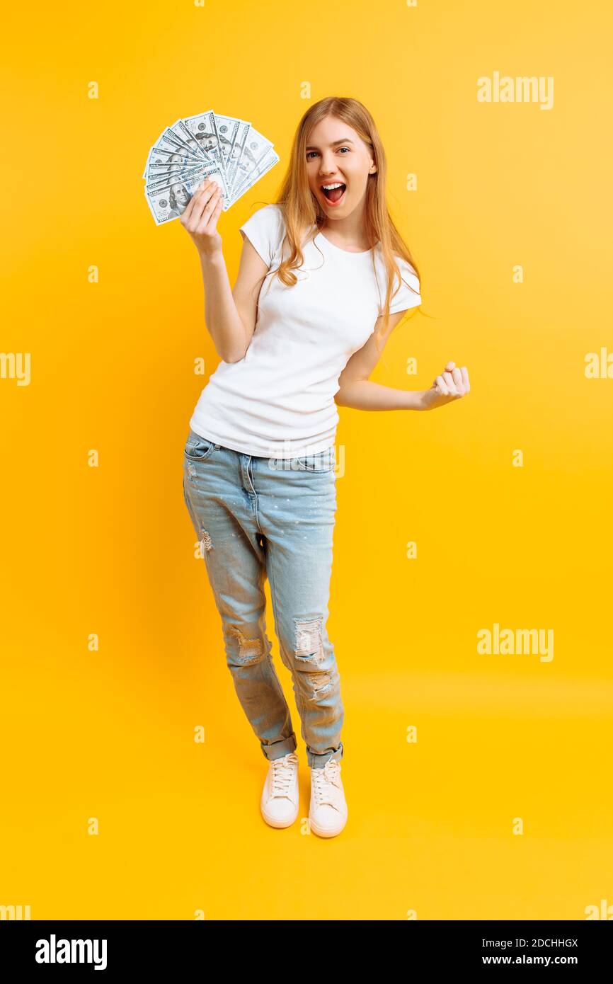 Portrait of happy contented girl in white t-shirt with a bunch of ...