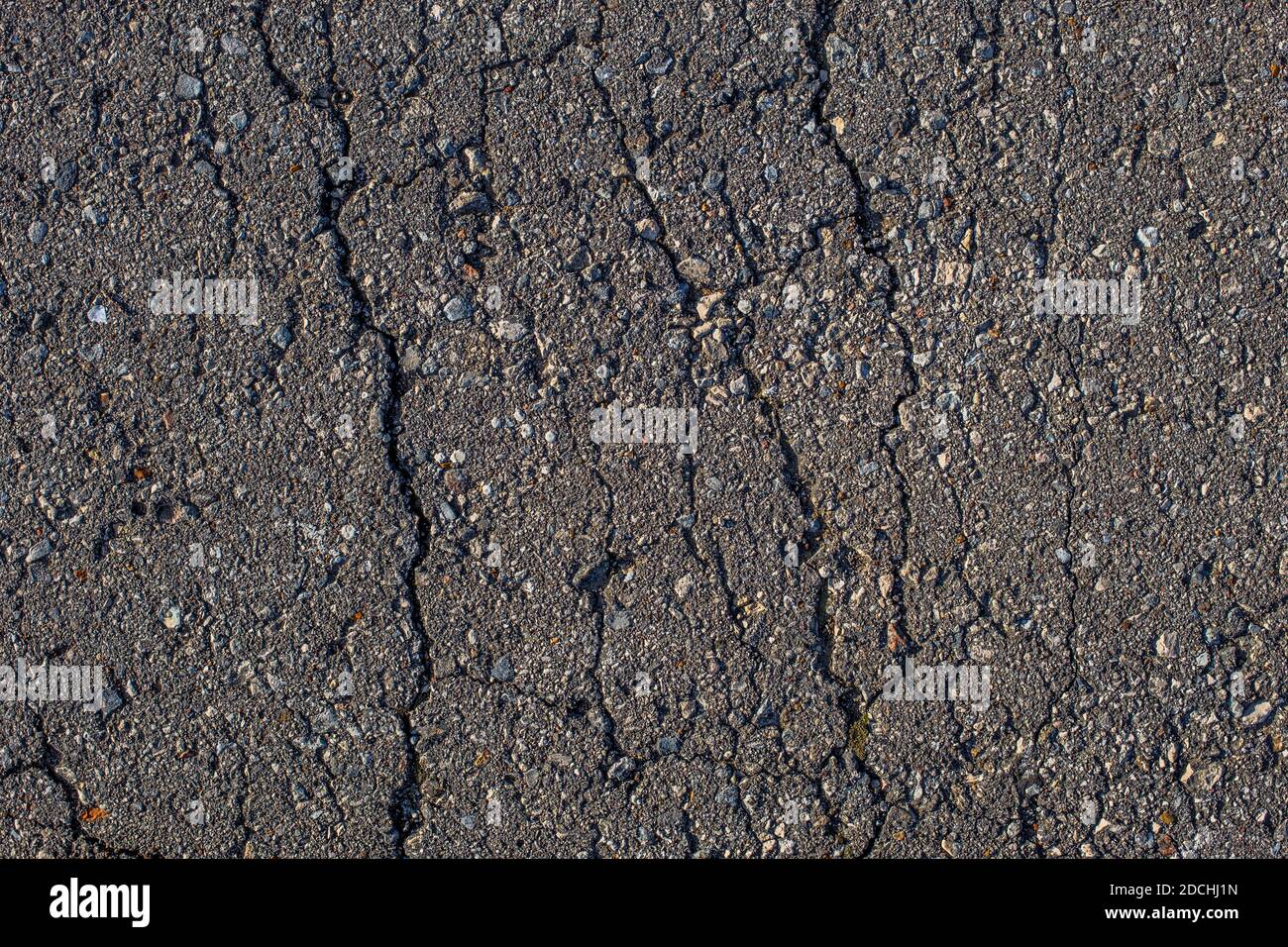 cracked across flat gray dry asphalt texture Stock Photo - Alamy