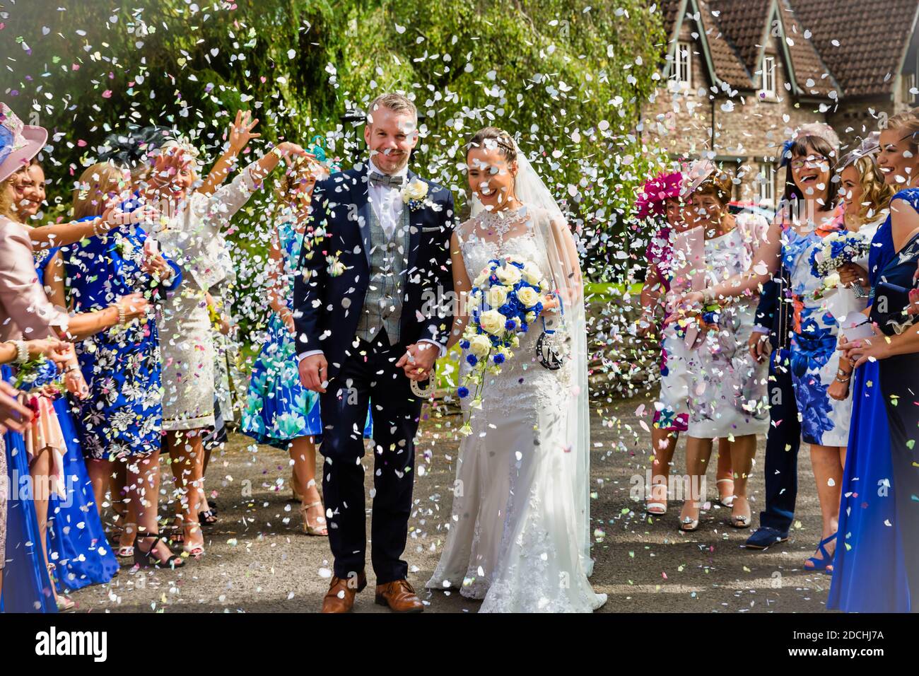 Wedding images. Confetti throwing over bride and groom Stock Photo - Alamy