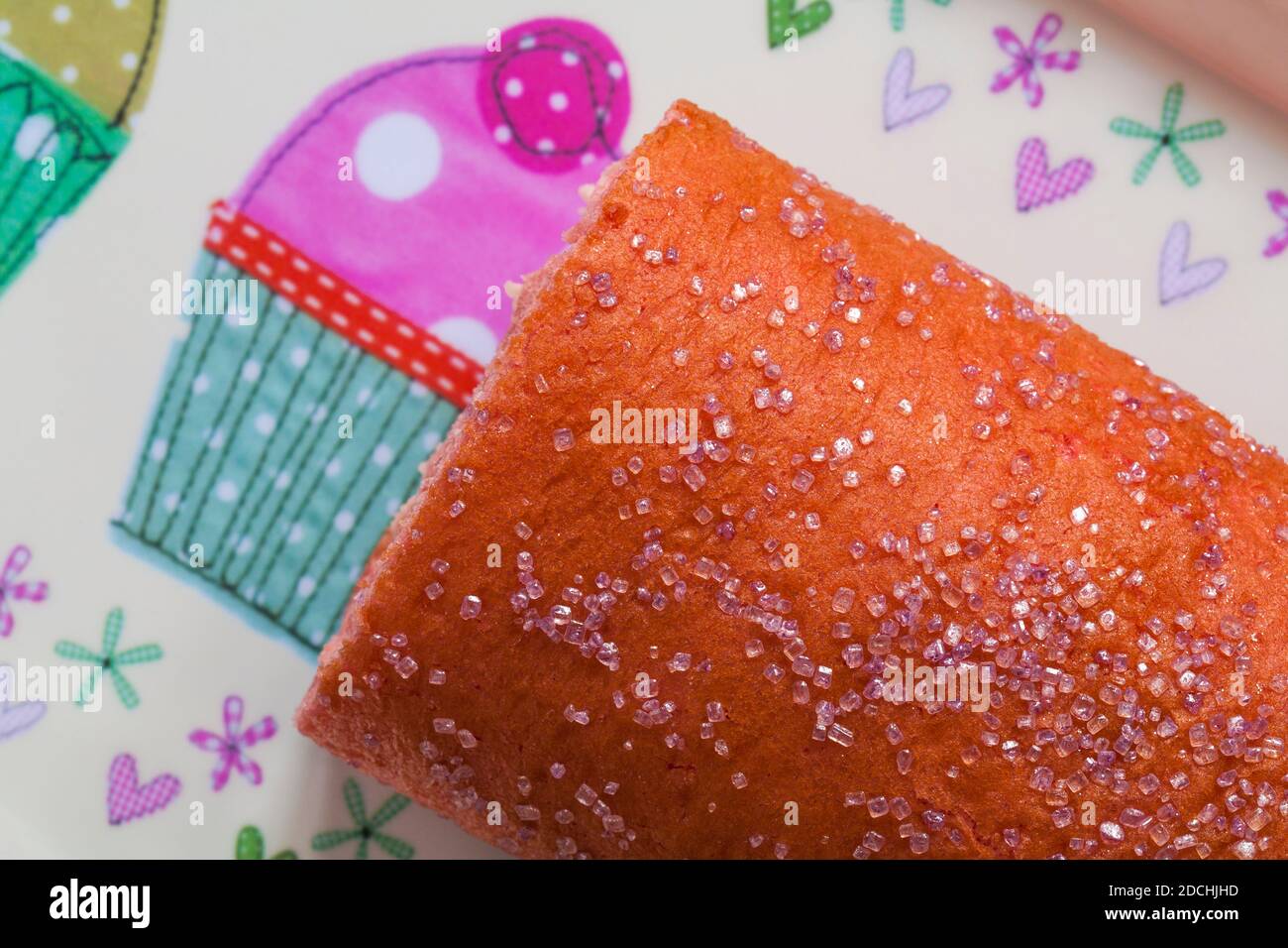 M&S Percy Pig sponge roll cake on plate - pink sponge roll filled with ...