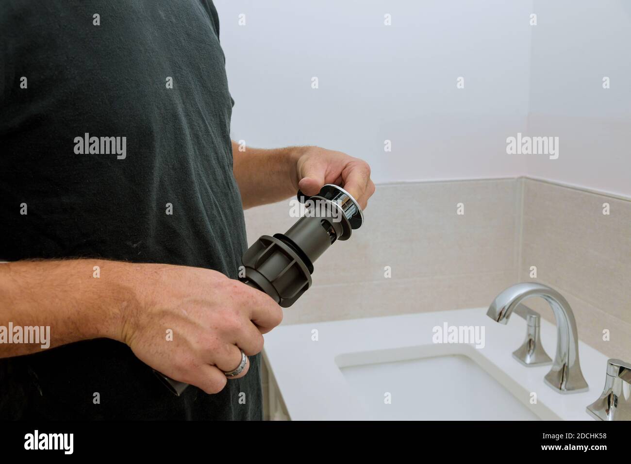 Hand plumber holds sewer drain an assembly near the faucet Stock Photo ...