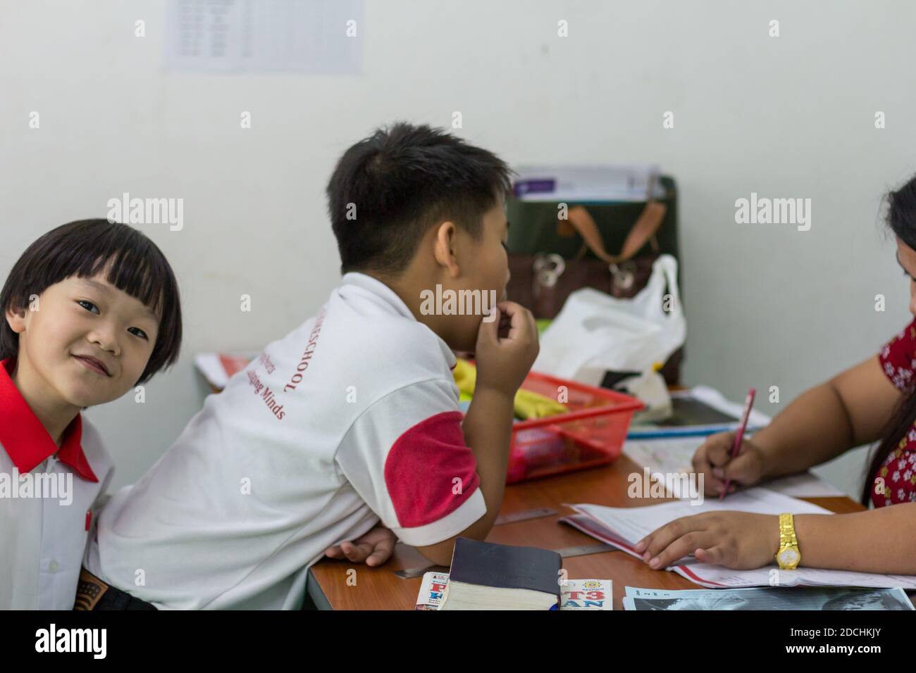 A teacher checking children's work Stock Photo - Alamy