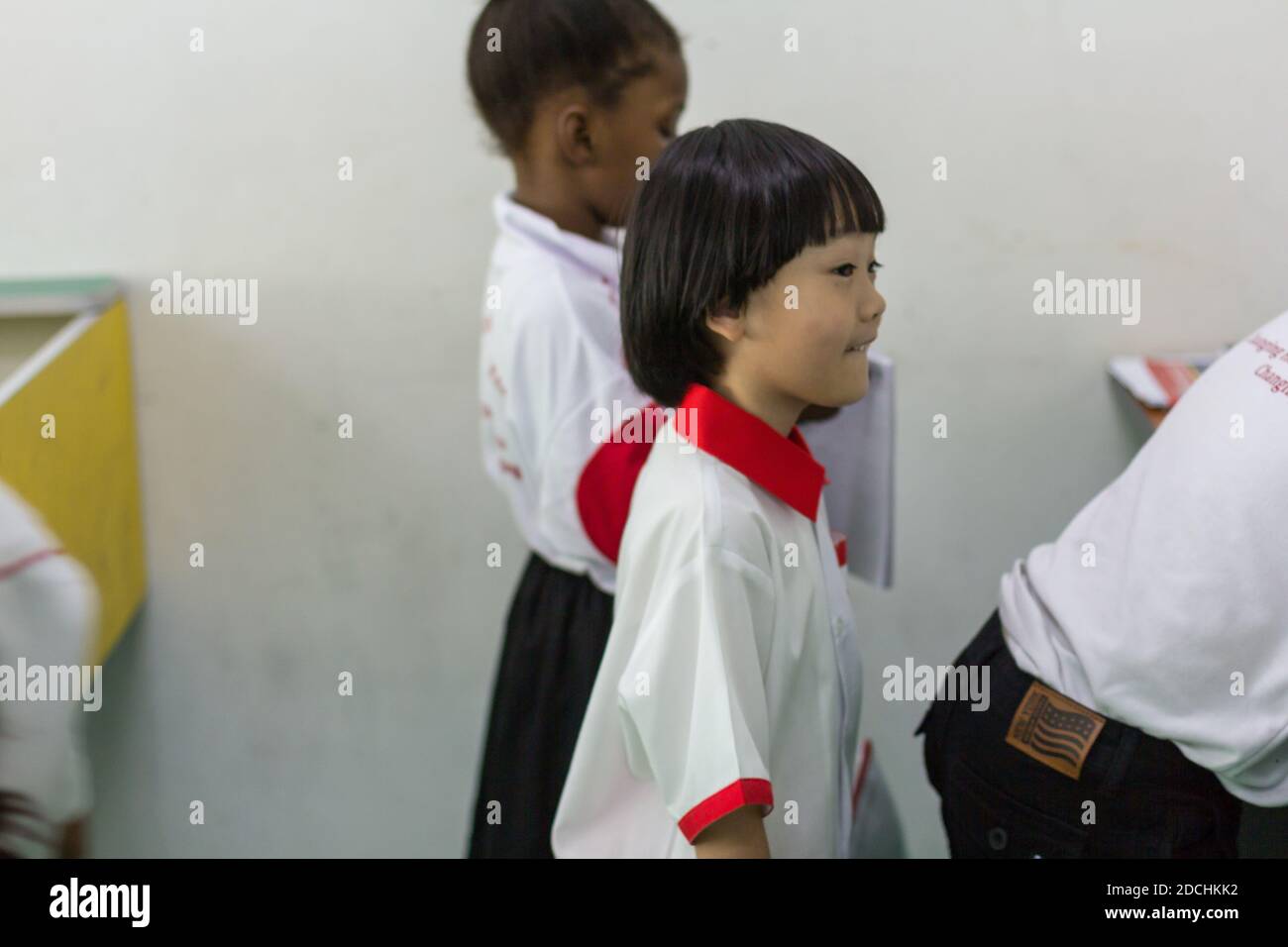 A teacher checking children's work Stock Photo - Alamy