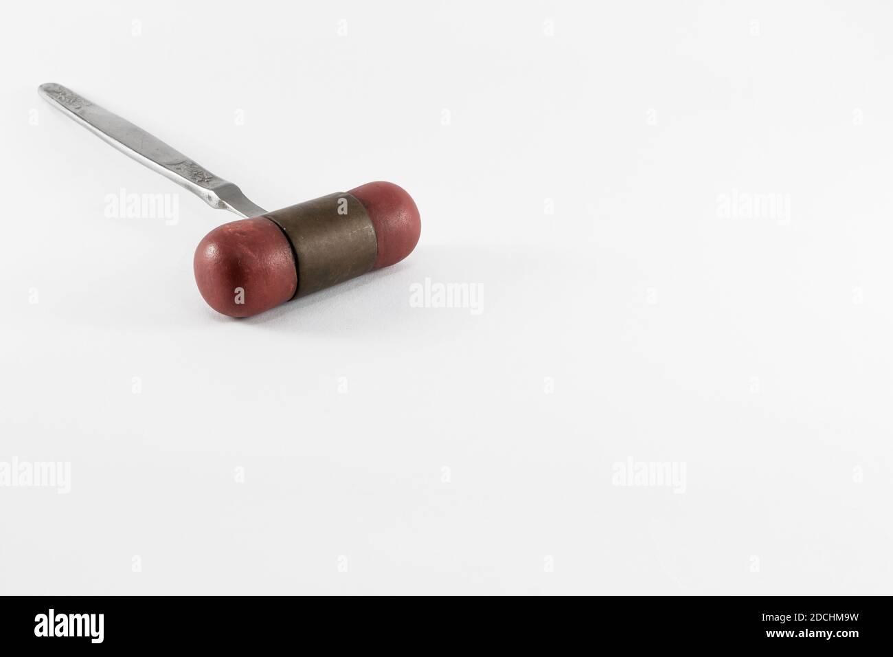 Isolated old vintage reflex hammer on white background. This medical ...