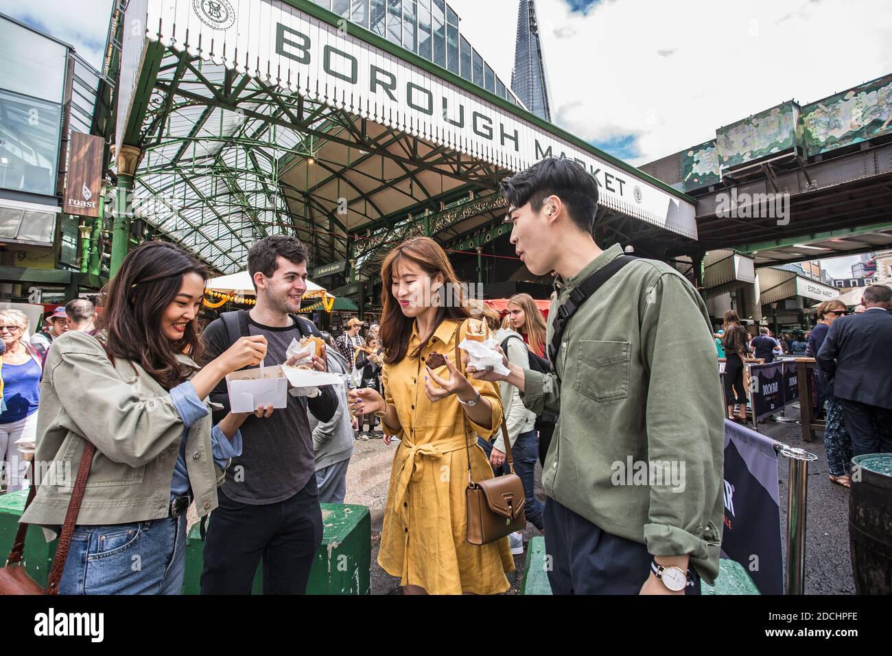 Great Britain / England /London , Group of friends eating street food ...