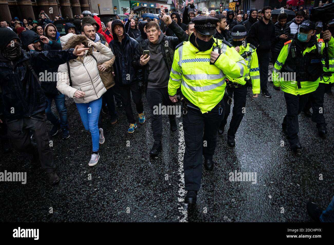 Police officers surround protesters during an anti-lockdown march.The ...