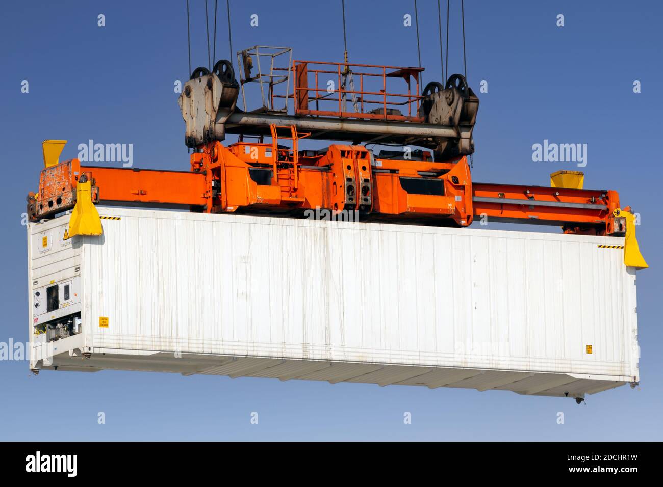 Shipping container lifted by gantry crane in the port Stock Photo - Alamy