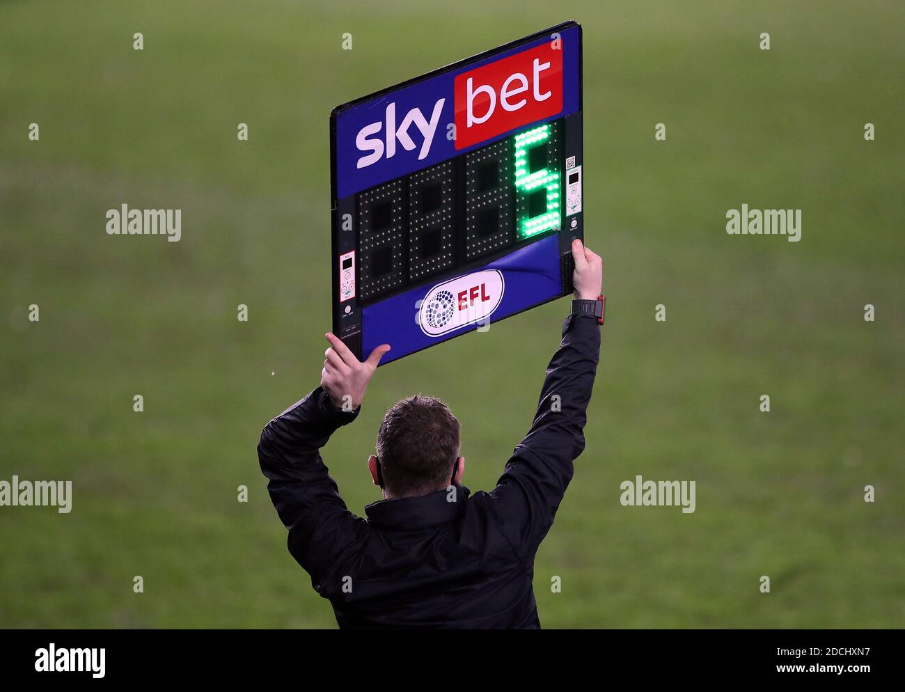 The fourth official holds up an electronic board showing the number ...