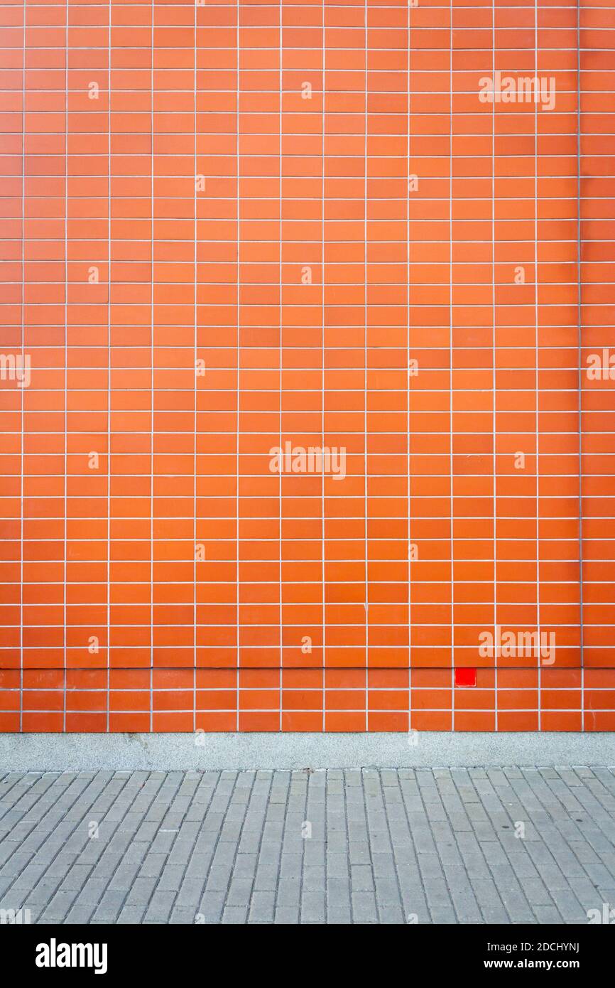 Modern red clay tile wall and a sidewalk Stock Photo - Alamy