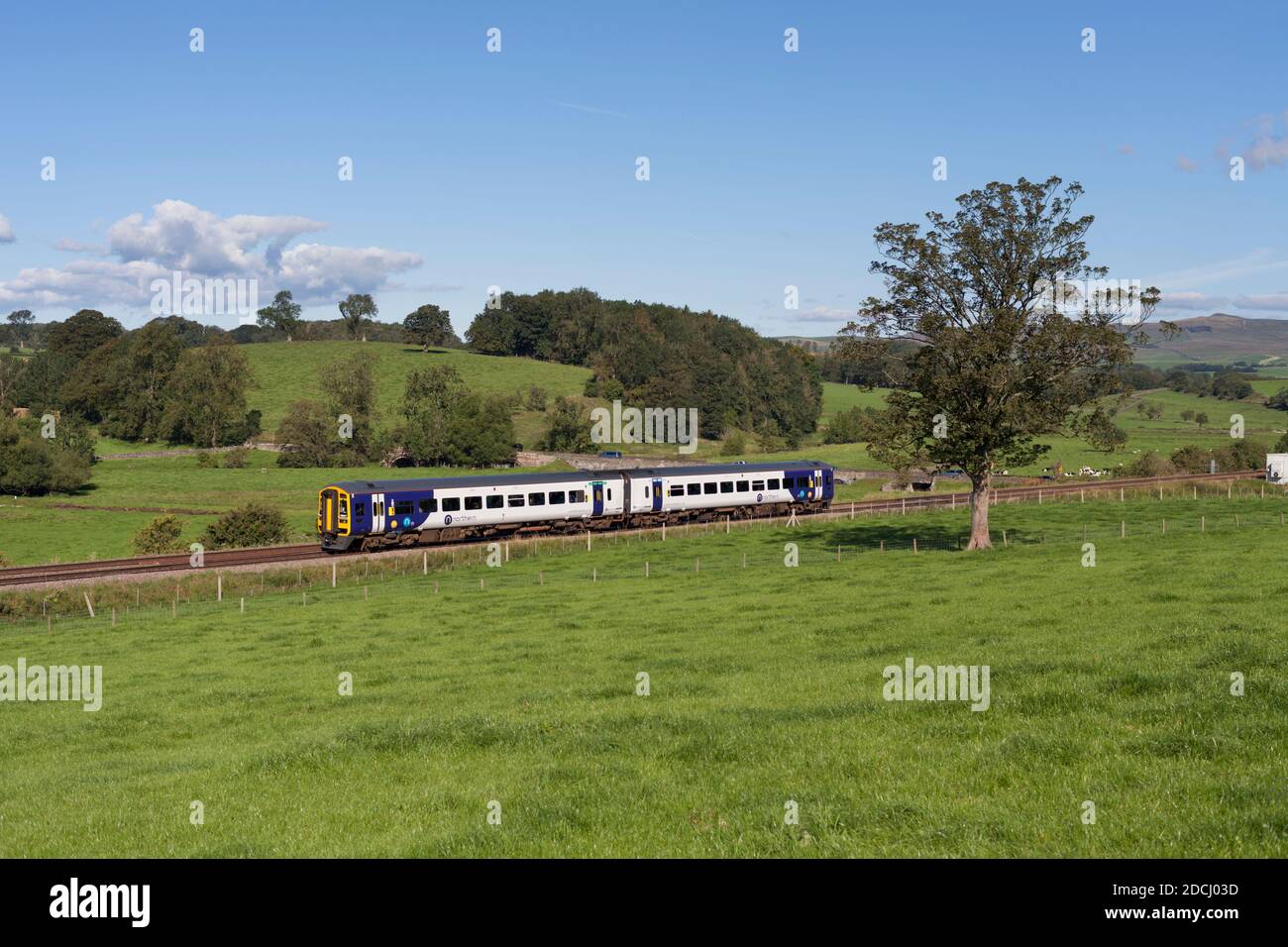 Northern Rail class 158 diesel train passing through the Aire valley countryside, Craven, North ...