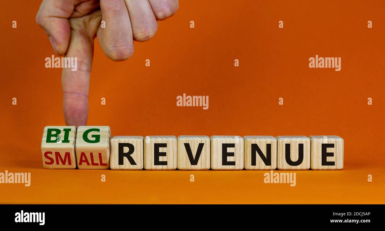 Symbol for a better revenue. Male hand turns wooden cubes and changes ...