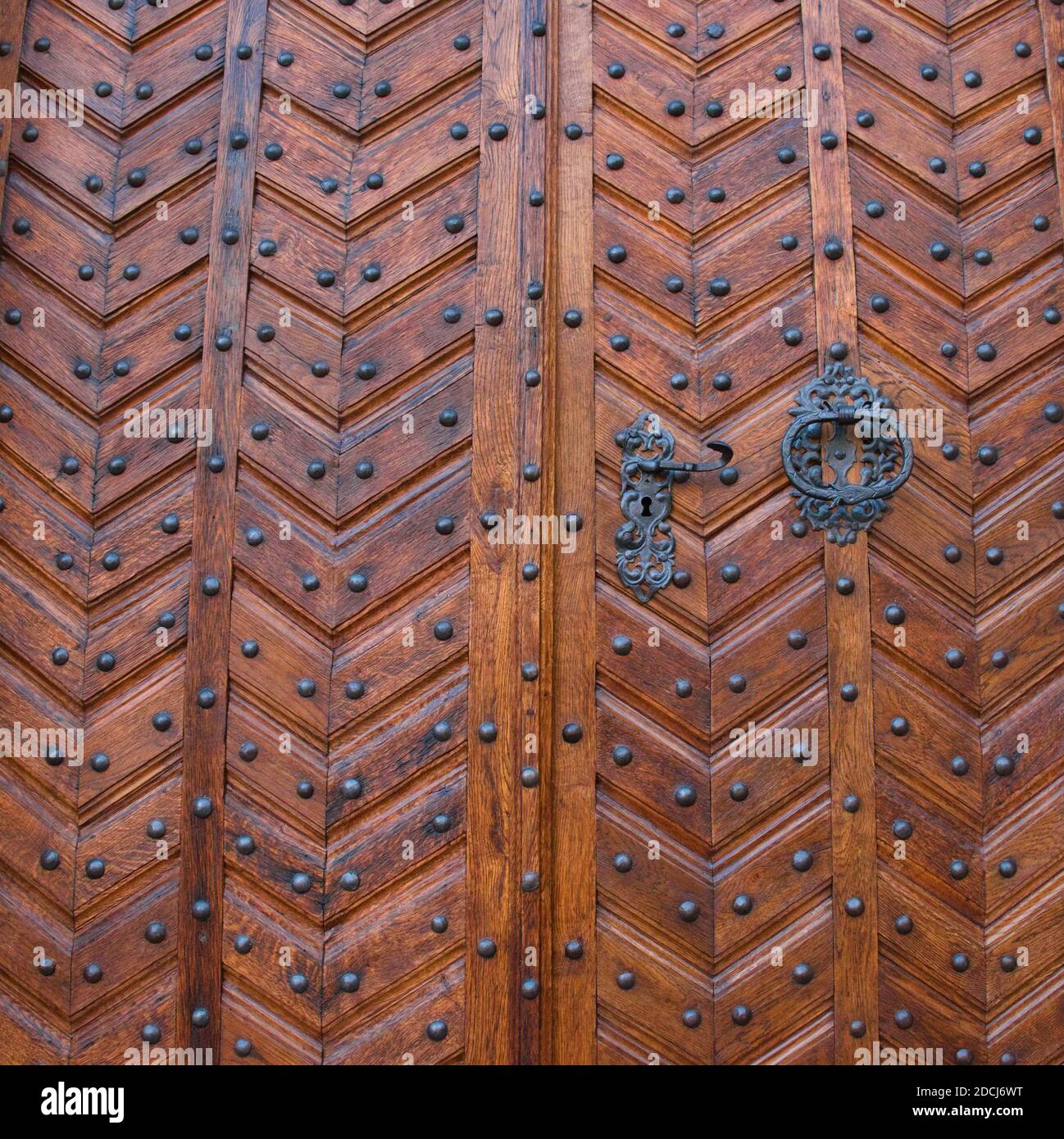 Old wooden door with rivets. Metal handle and door lock Stock Photo - Alamy