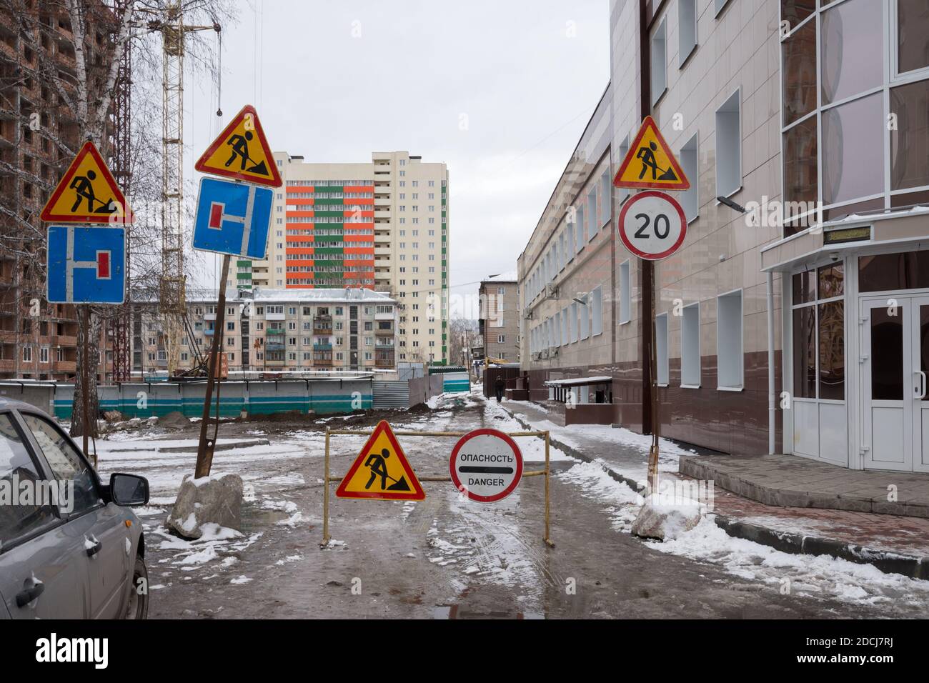 Warning road signs and speed limit signs stand in a side street at the ...