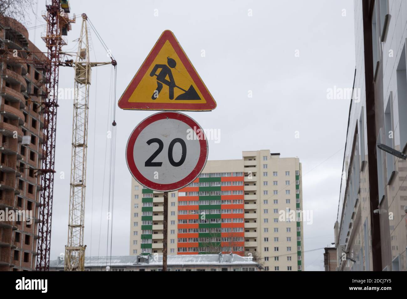Warning road sign and speed limit sign stand in a side street at the ...