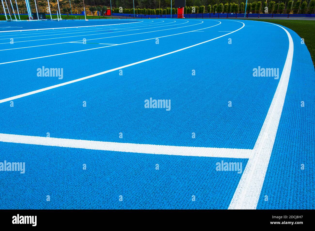 New blue running track and stadium background Stock Photo - Alamy