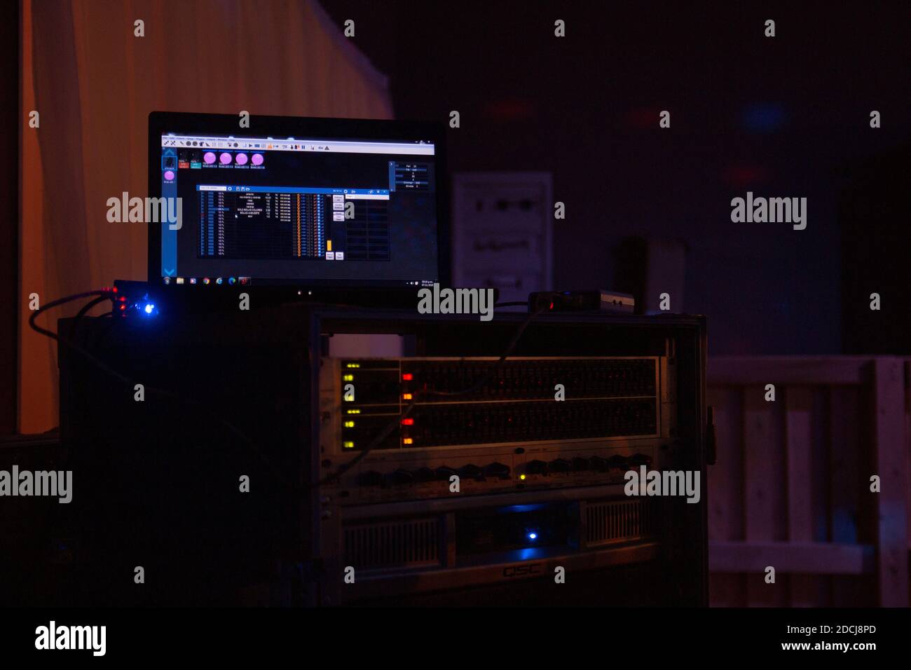 A DJ table setup with sound control screen and various track controls ...