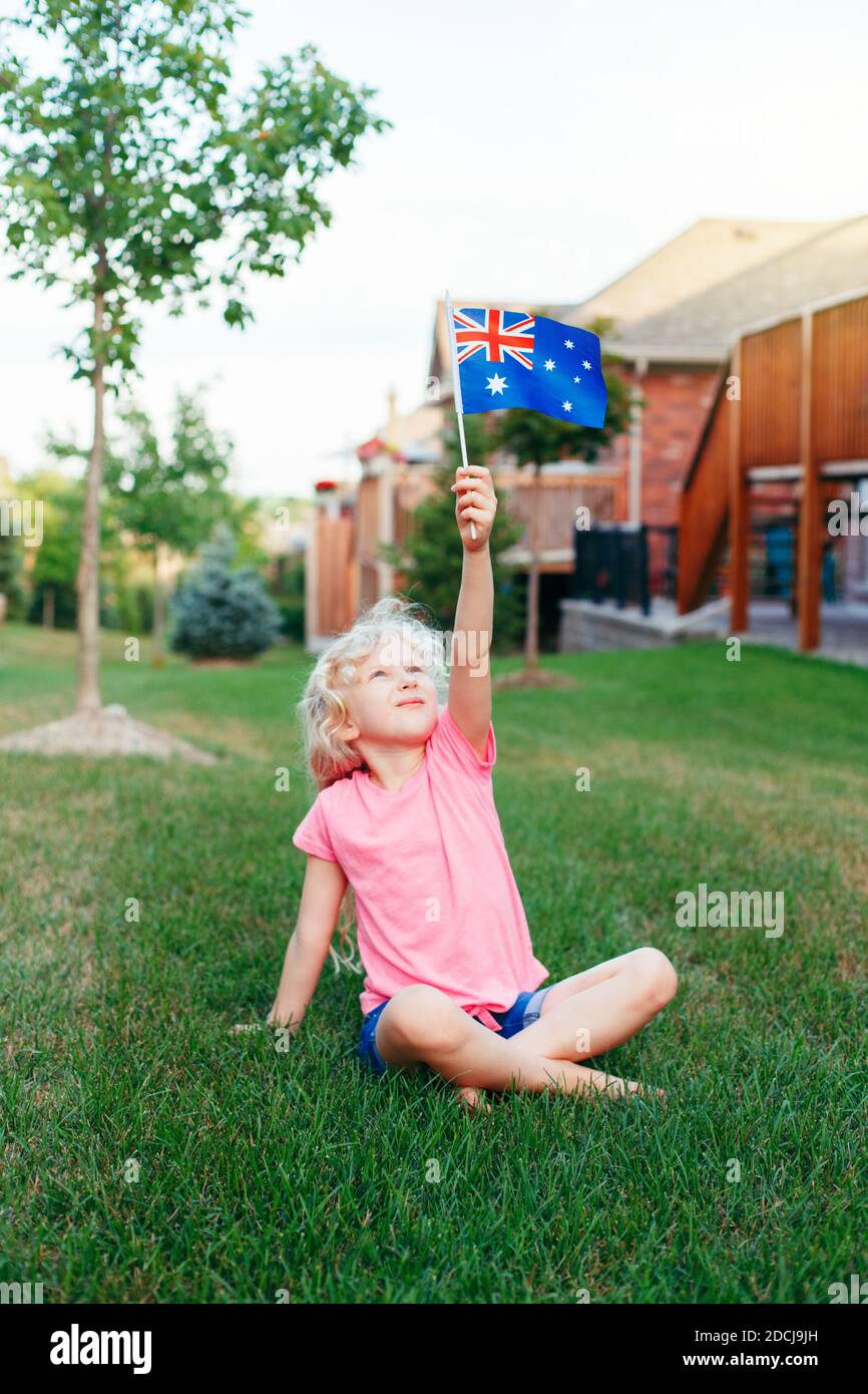 Happy Caucasian blonde girl holding Australian flag. Smiling child ...