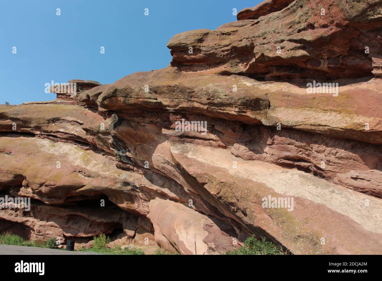 A huge red rock formation alongside a parking lot in Red Rocks State ...