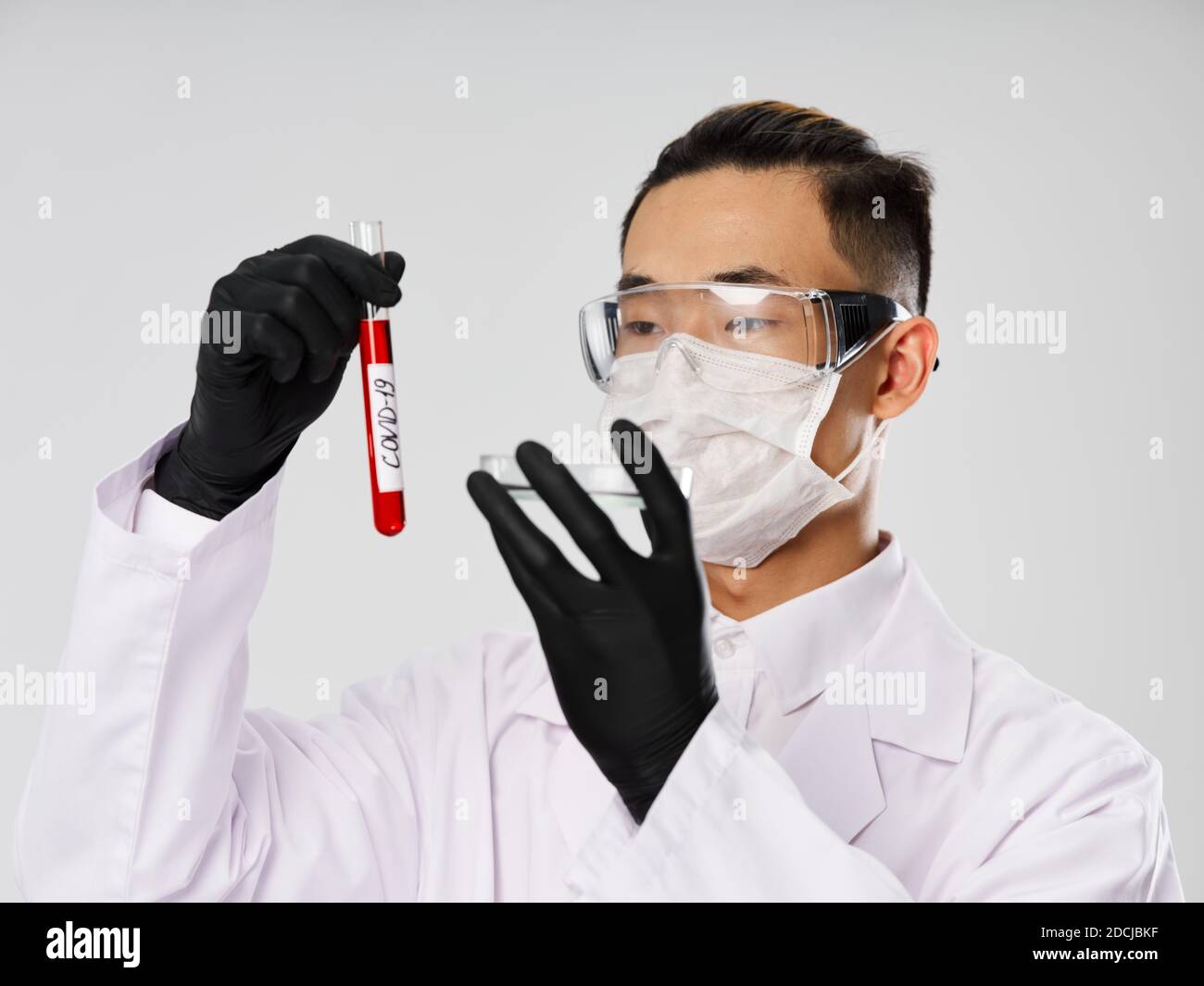 Man of Asian appearance protective mask blood test examination ...