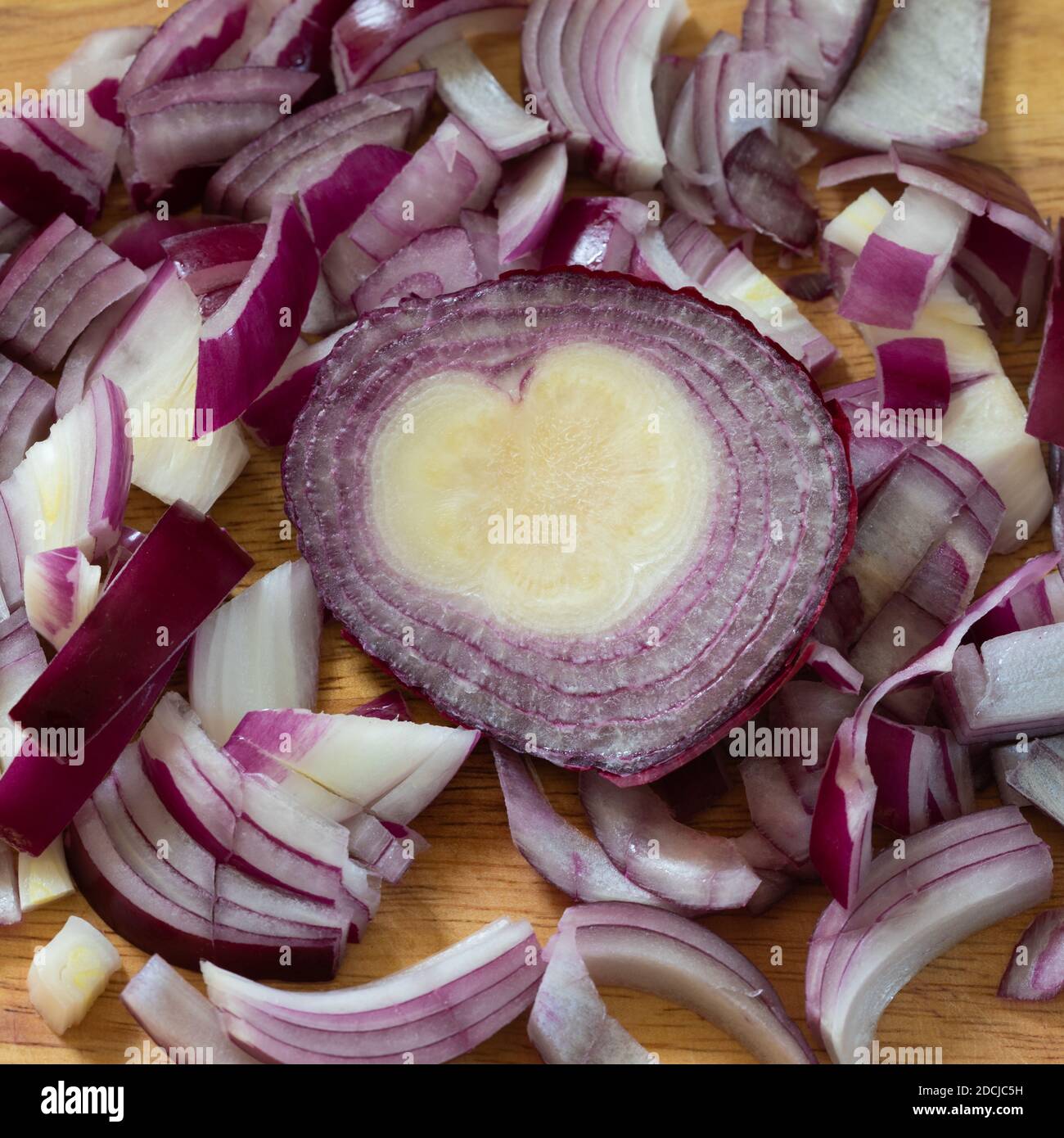 sliced red onion with heart shaped slice on wooden chopping board Stock ...