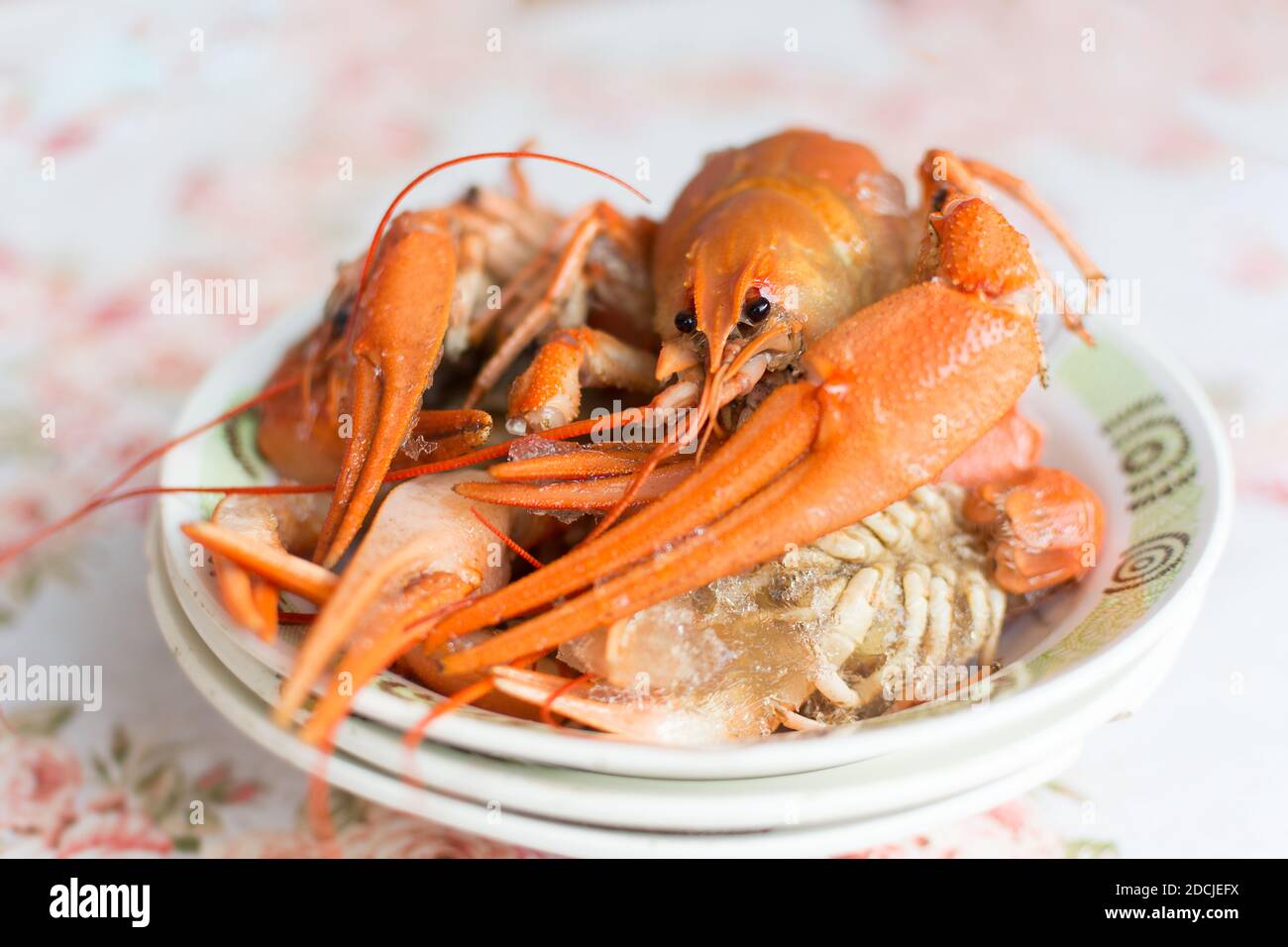 Plate with boiled crawfish on a desk Stock Photo - Alamy
