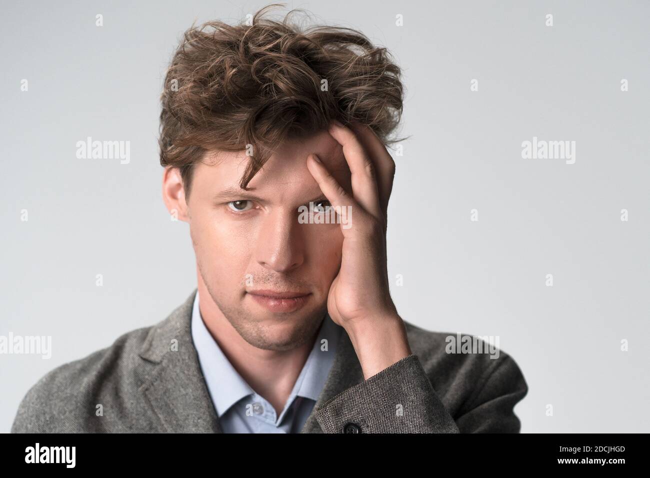 Young sad thoughtful man having headache after work. Exhausted young ...