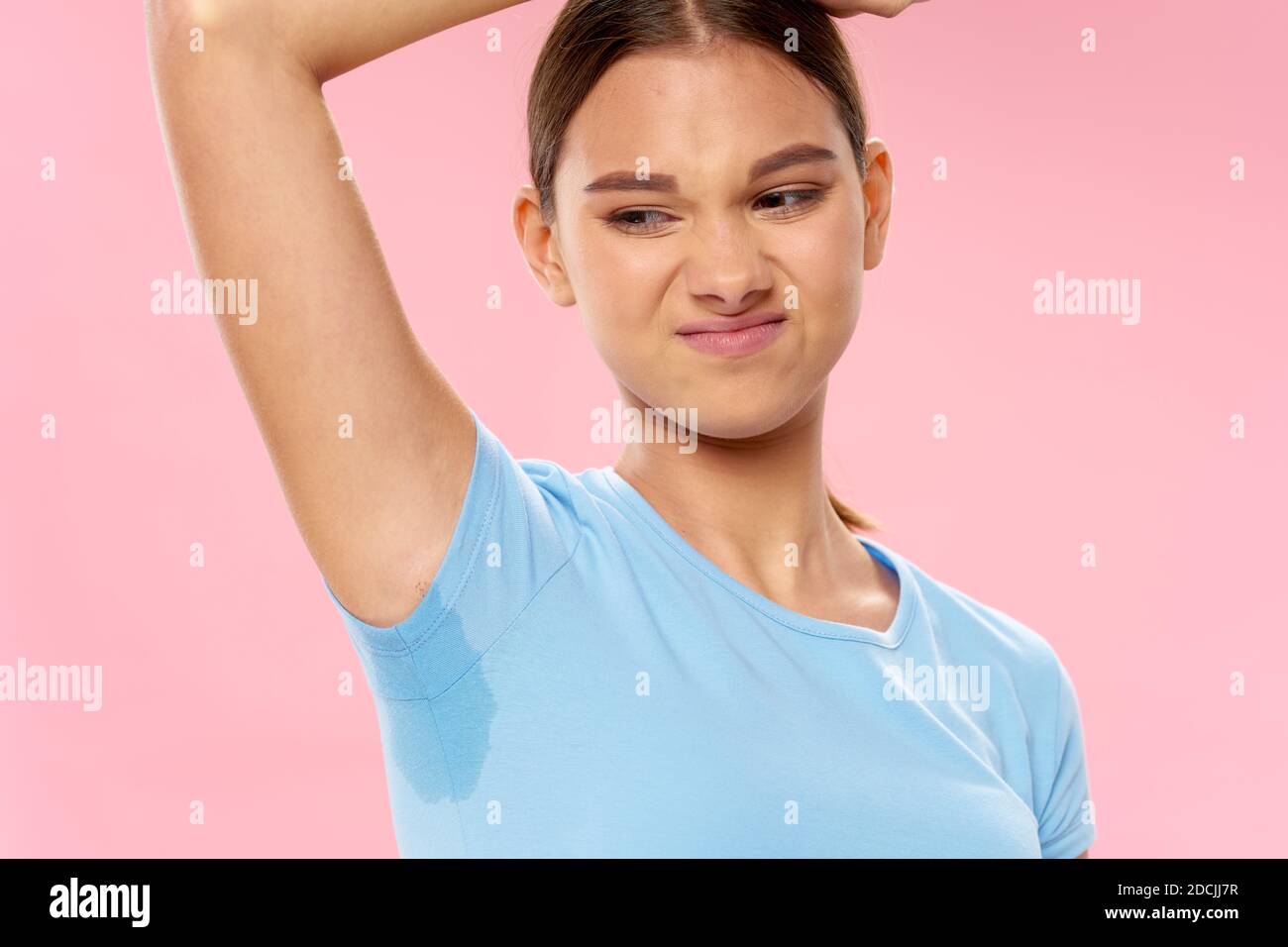 girl with sweaty armpit bad smell health problems pink Stock Photo - Alamy