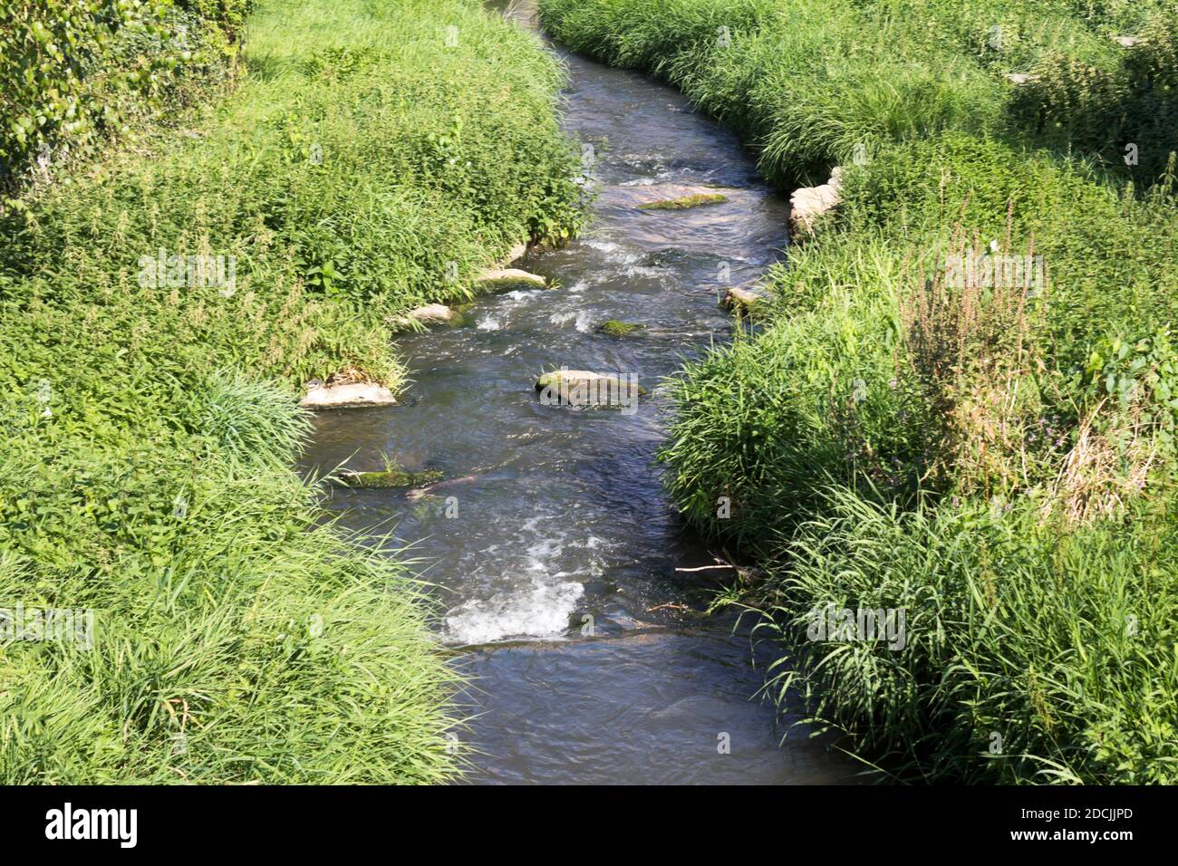 Rural landscape with a small curved stream Stock Photo - Alamy