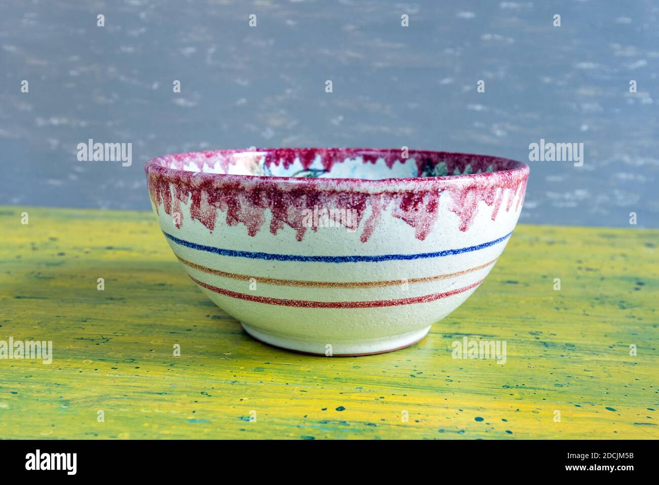 Pretty painted colorful pottery bowl on yellow background Stock Photo ...