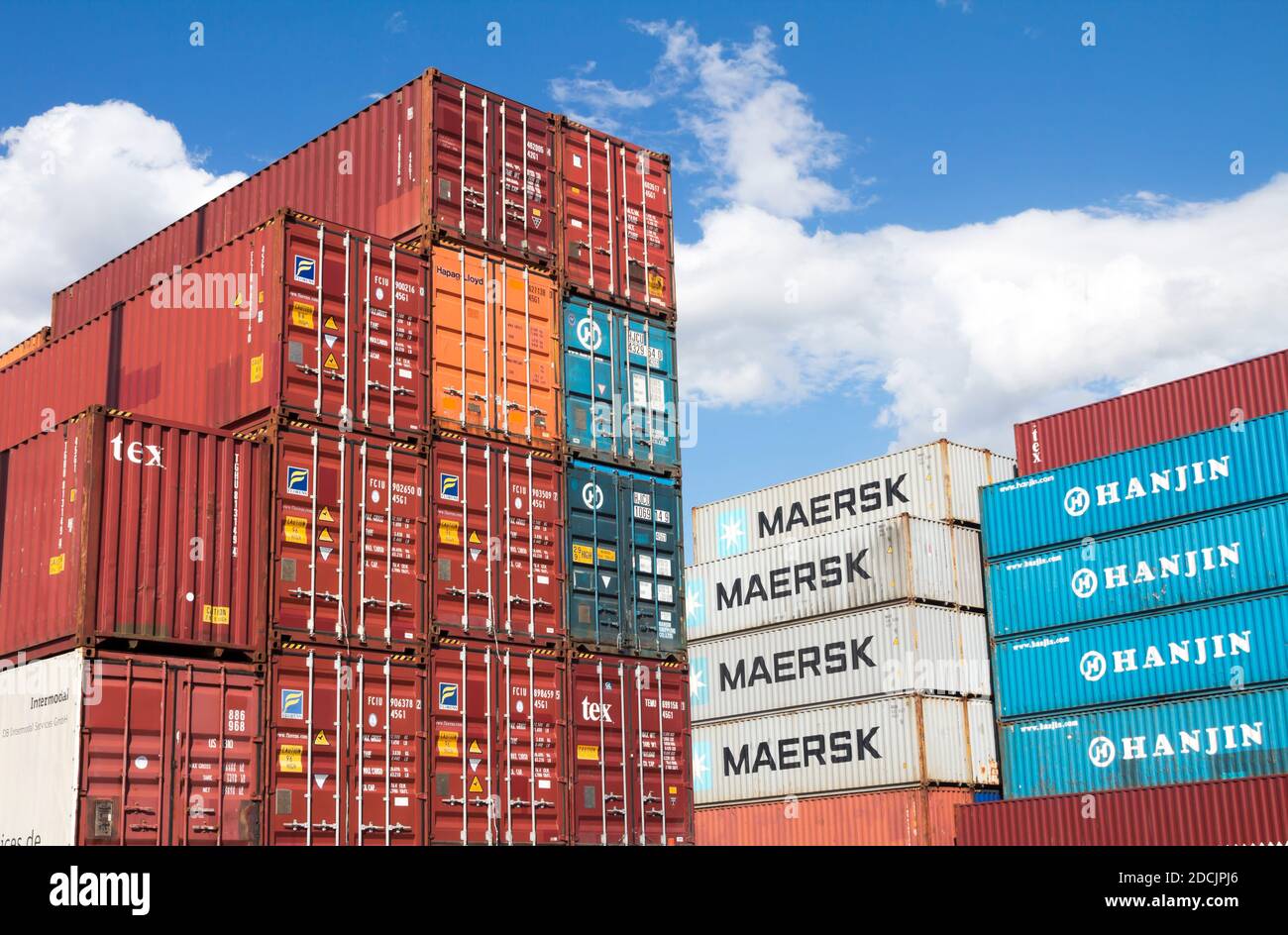 Stacked cargo containers in storage area of freight Stock Photo - Alamy