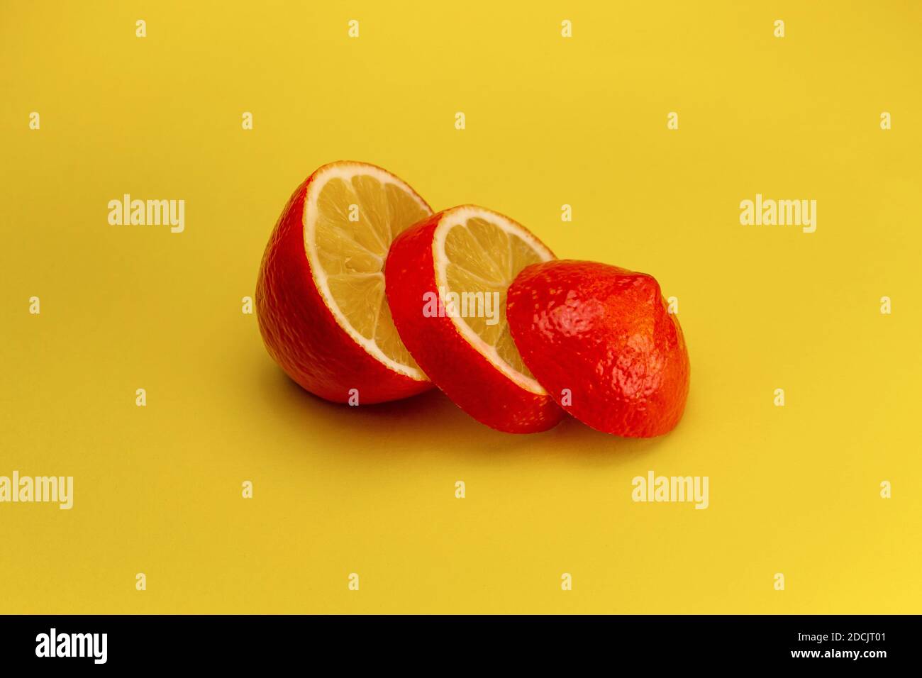 Red lemon sliced on yellow background. Abstract health concept Stock ...