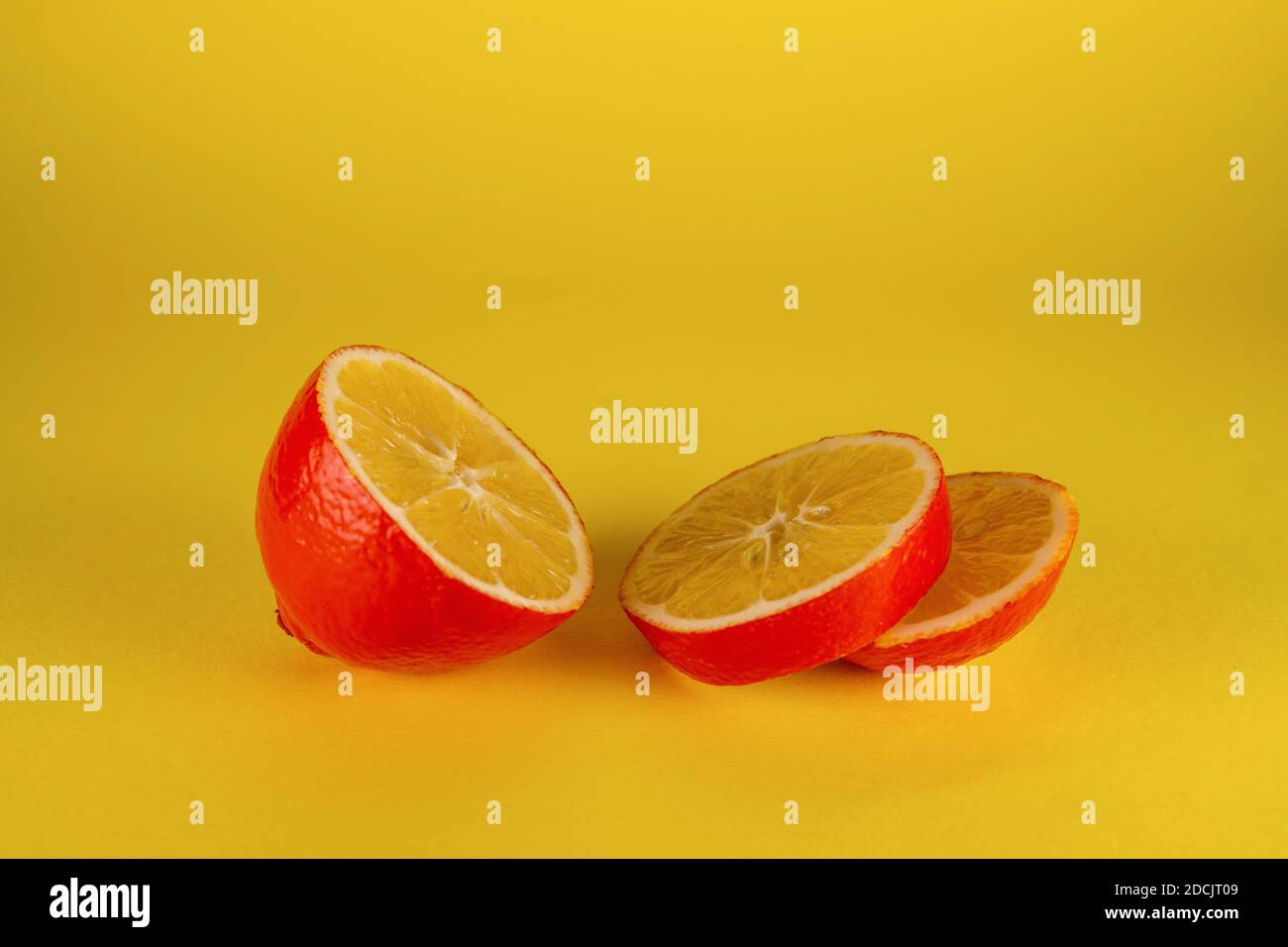 Red lemon sliced on yellow background. Abstract health concept Stock ...