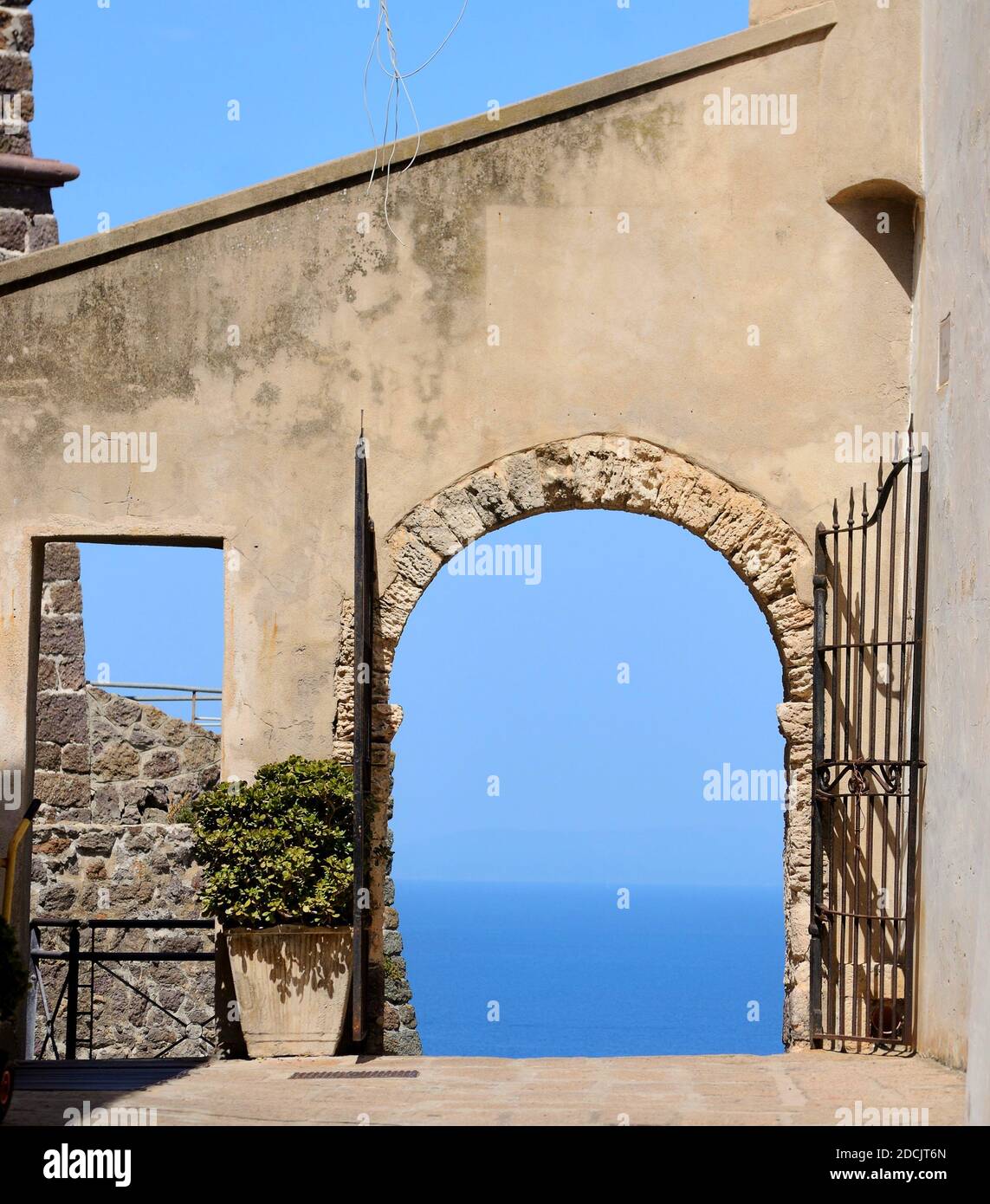 Looking at the mediterranean sea through arch door Stock Photo - Alamy