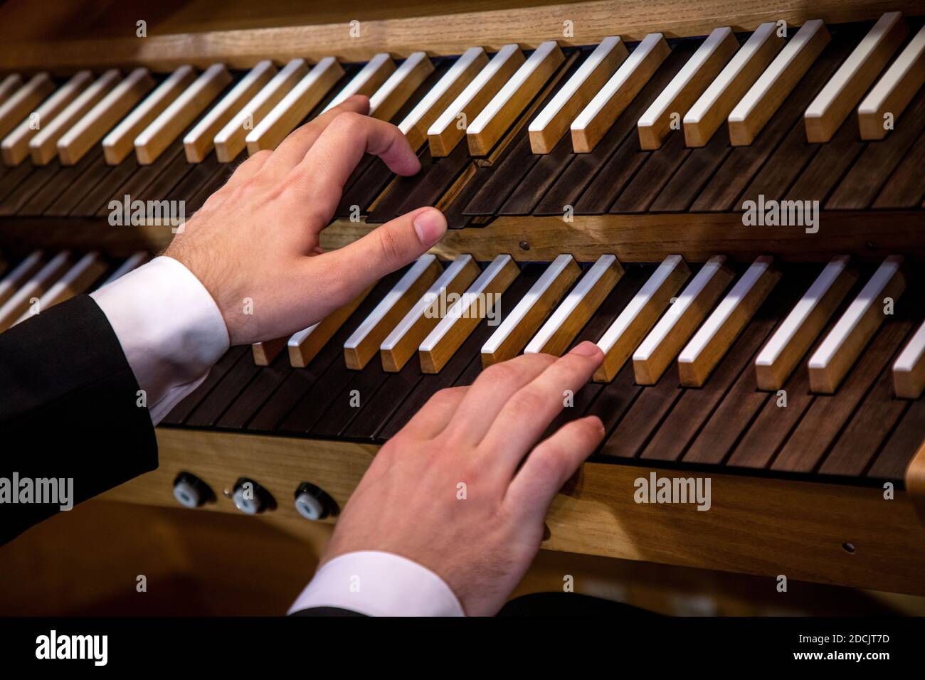 Close up view of a organist hands playing a pipe organ Stock Photo - Alamy