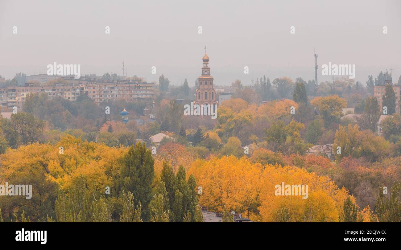 Beautiful autumn landscape with bell tower on grey sky background ...