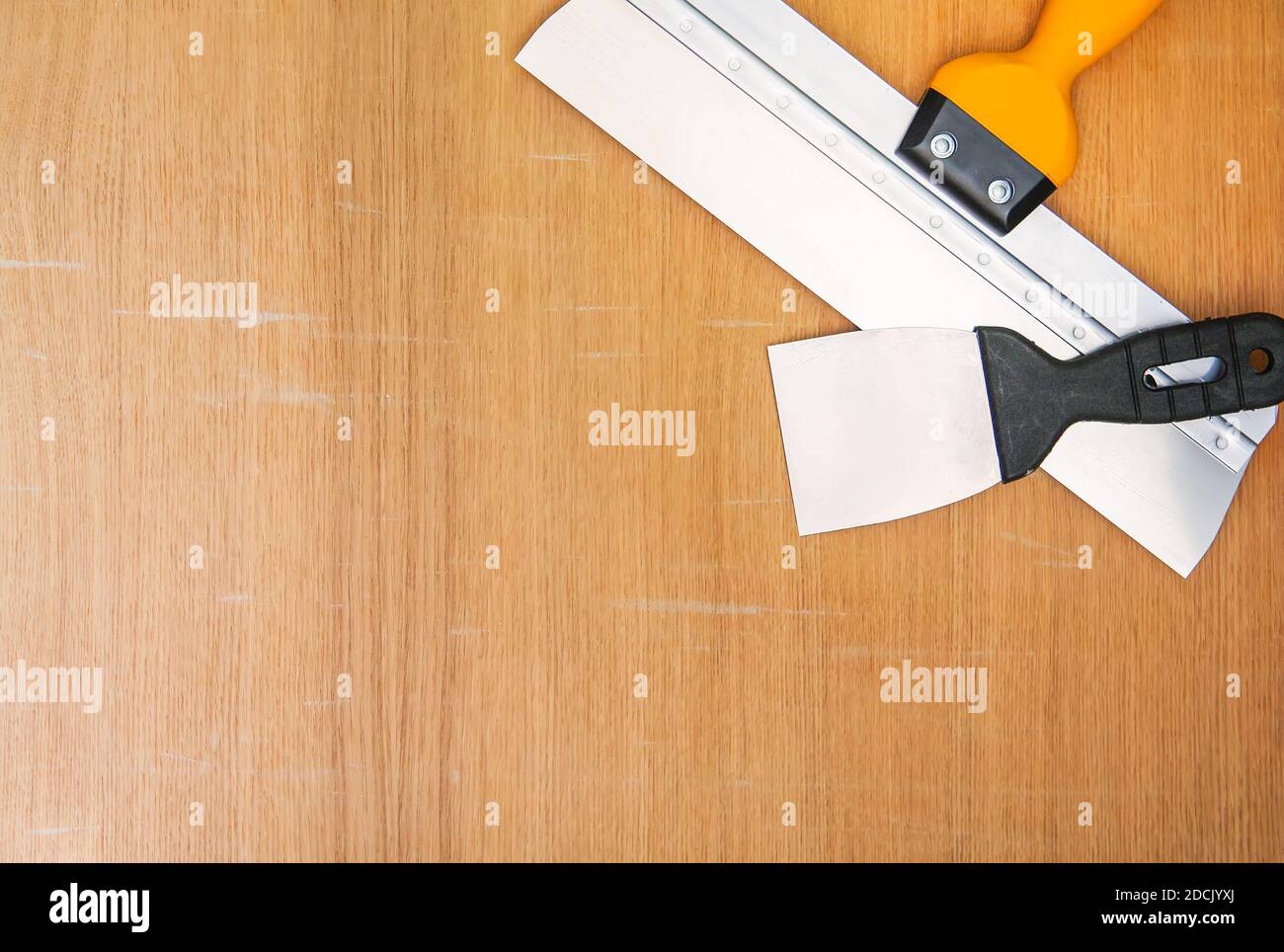 Two spatulas for home repair. Wide and narrow tools on wooden ...