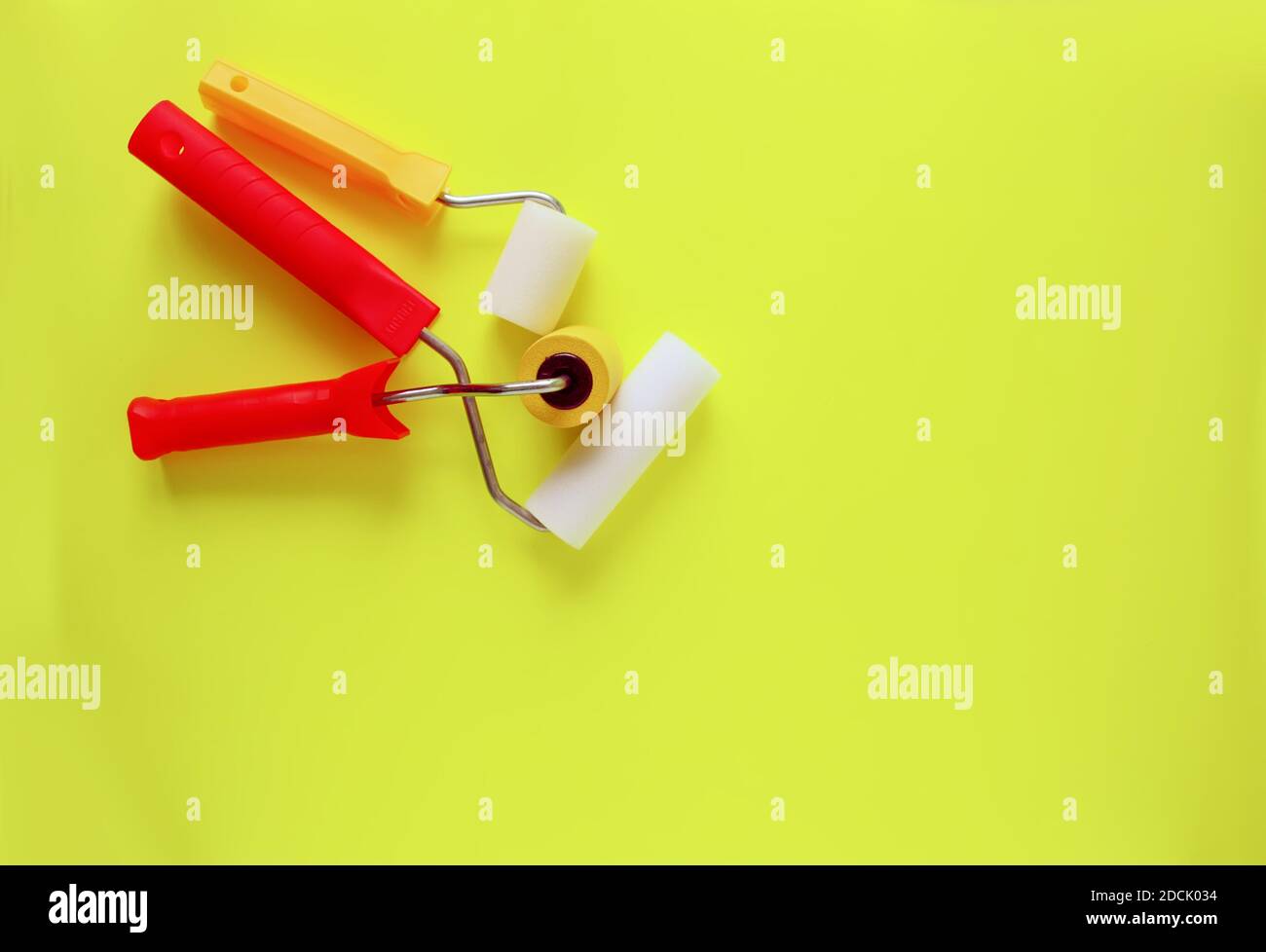 Home repair tools on bright yellow background. Two foam rollers for ...