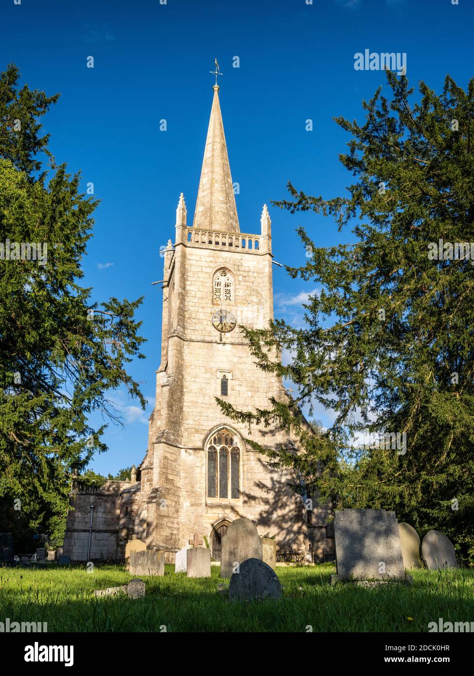 Sun shines on the traditional gothic tower of St Cyr's parish church in ...