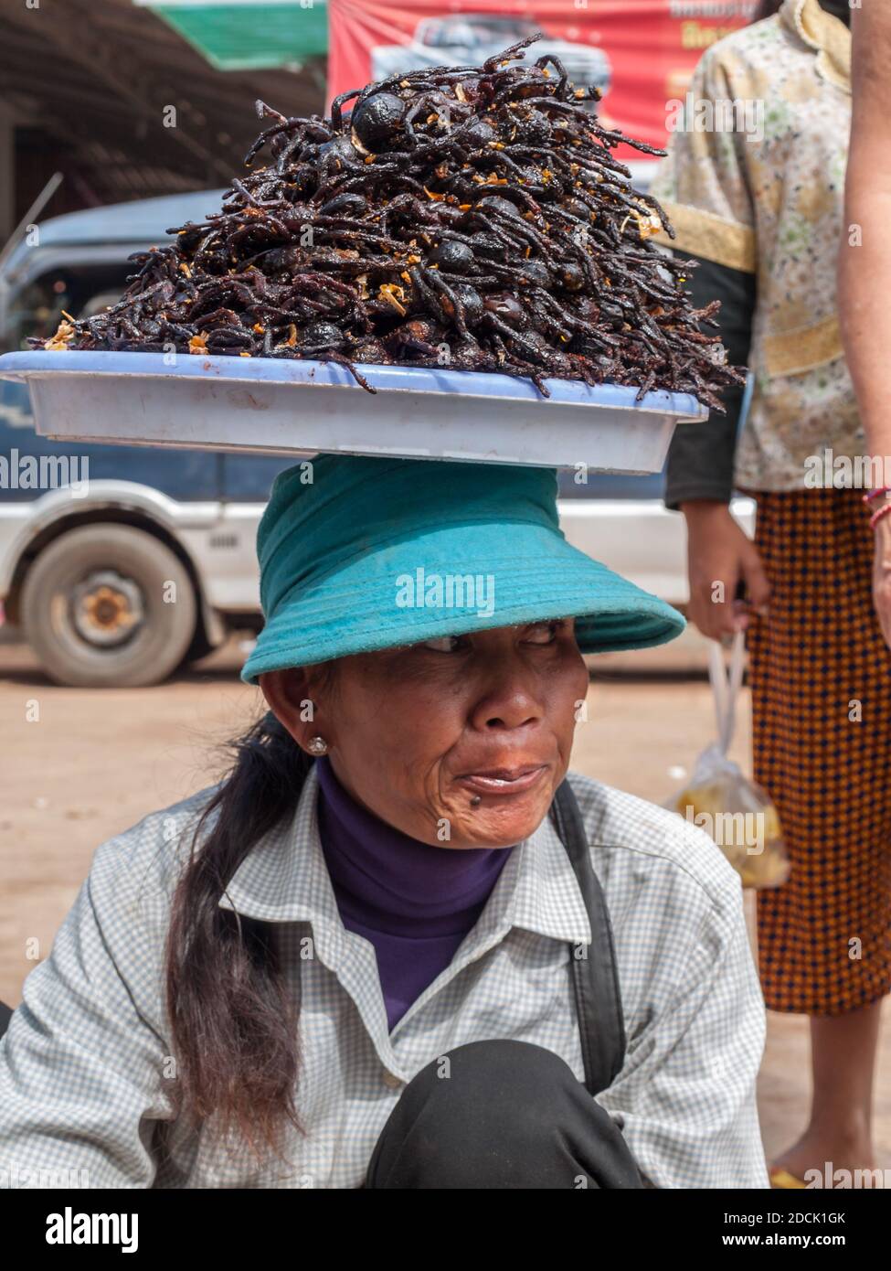 Cambodian woman selling deep fried tarantulas in Skuon Stock Photo - Alamy